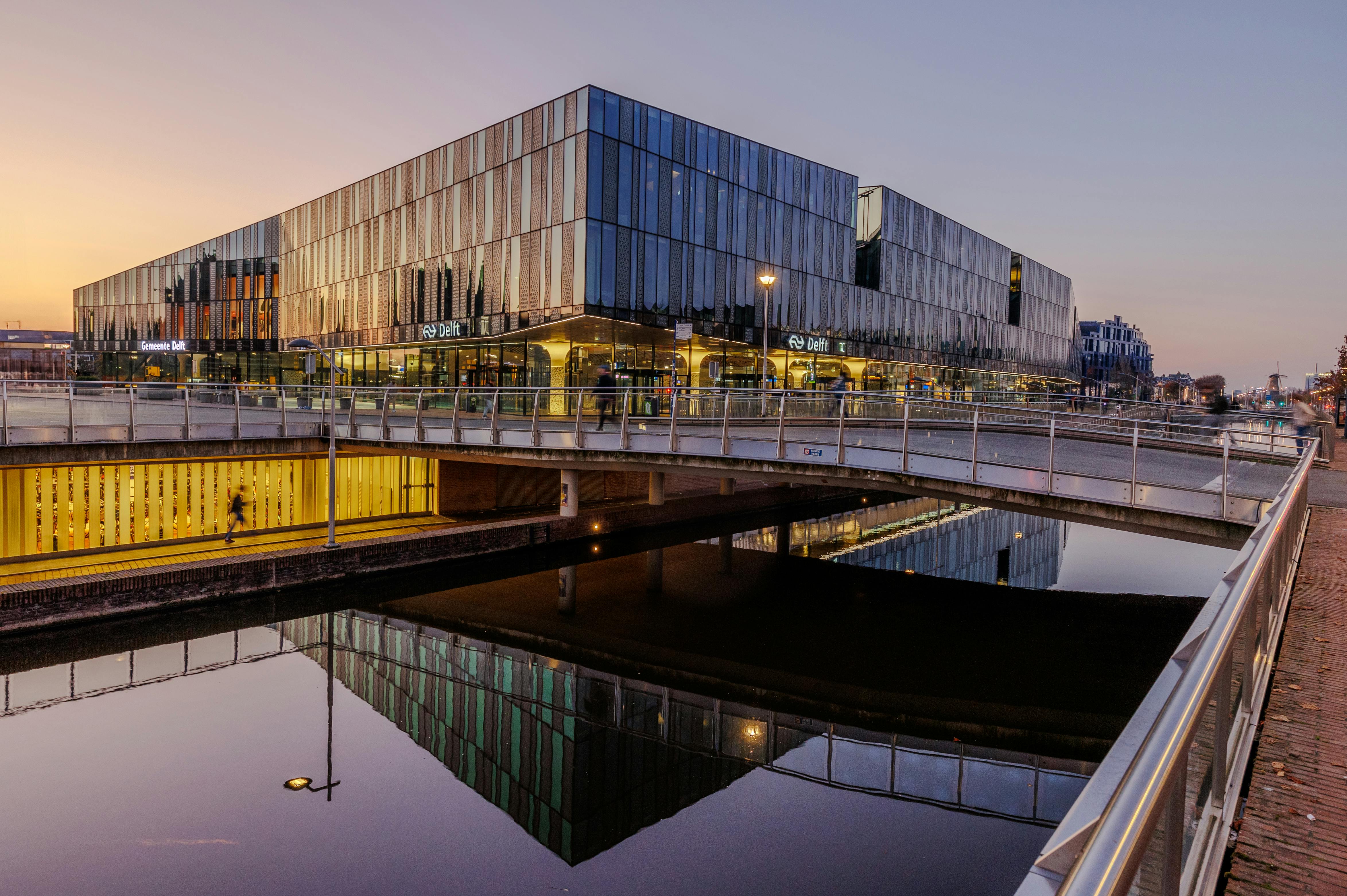 Modern Delft Train Station at Sunset with Reflections · Free Stock Photo