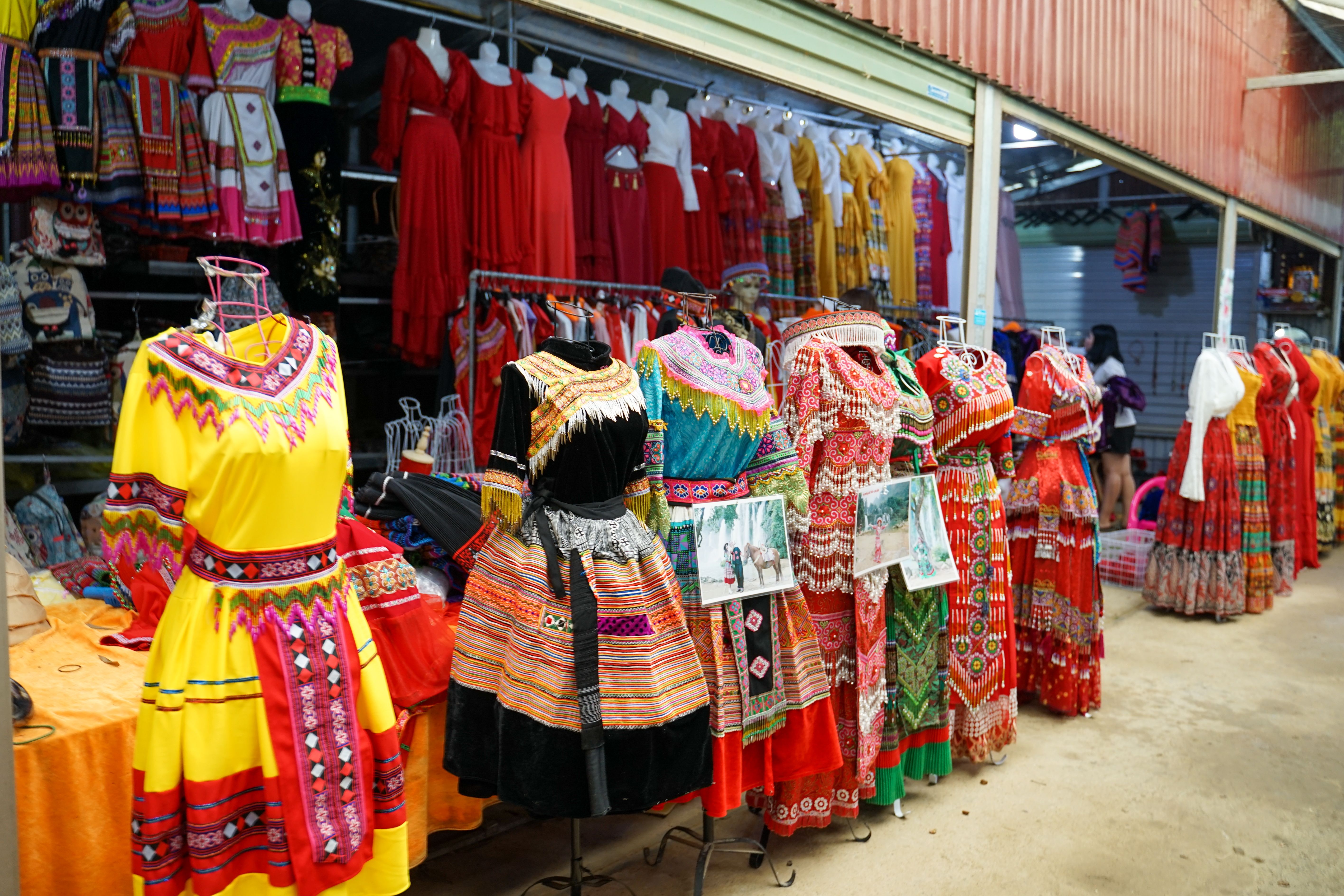 Vibrant Traditional Dresses Display in Market · Free Stock Photo