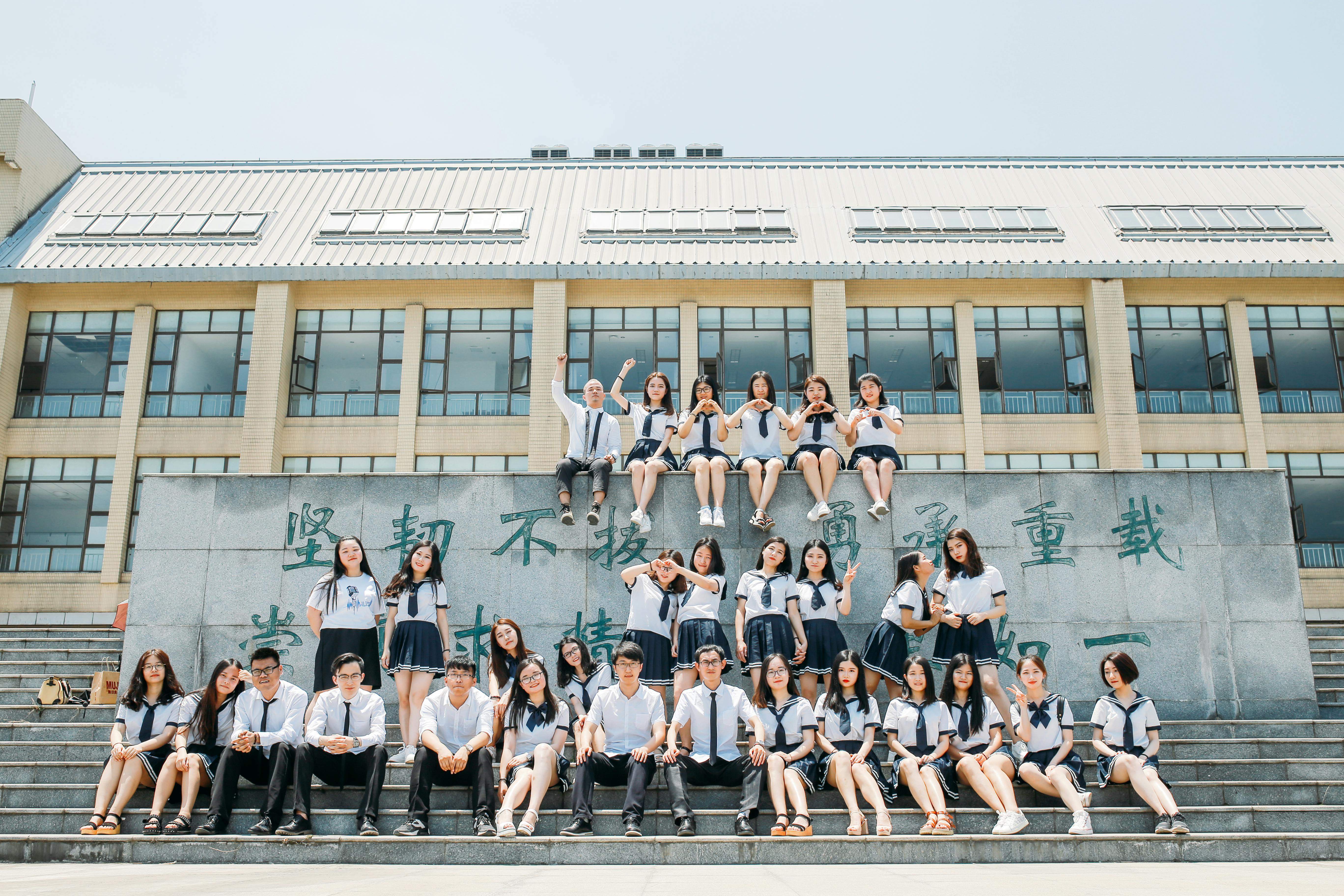 Group of Students Posing Outdoors in Uniforms · Free Stock Photo