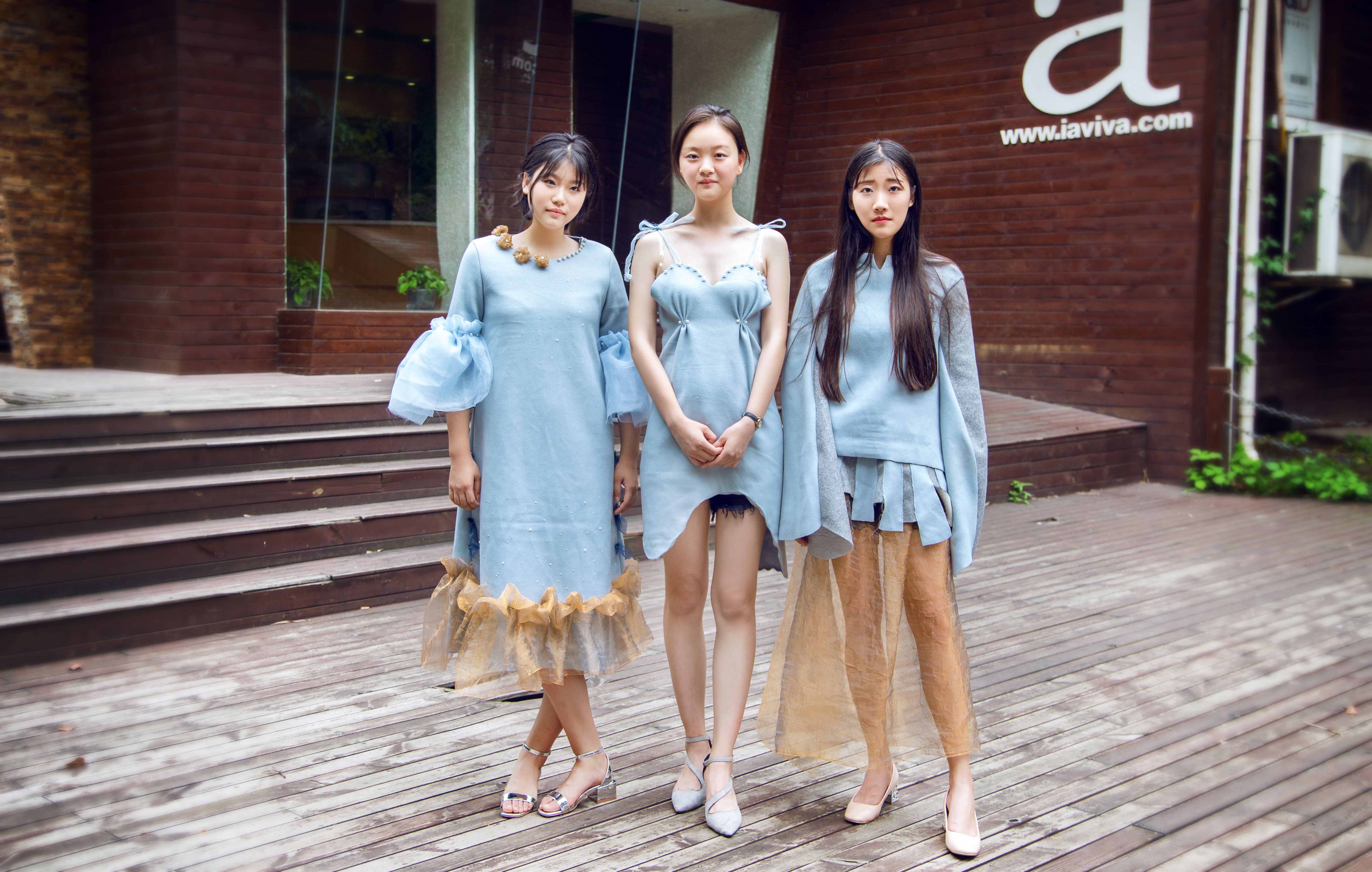Three Women in Pastel Outfits Posing Outdoors · Free Stock Photo