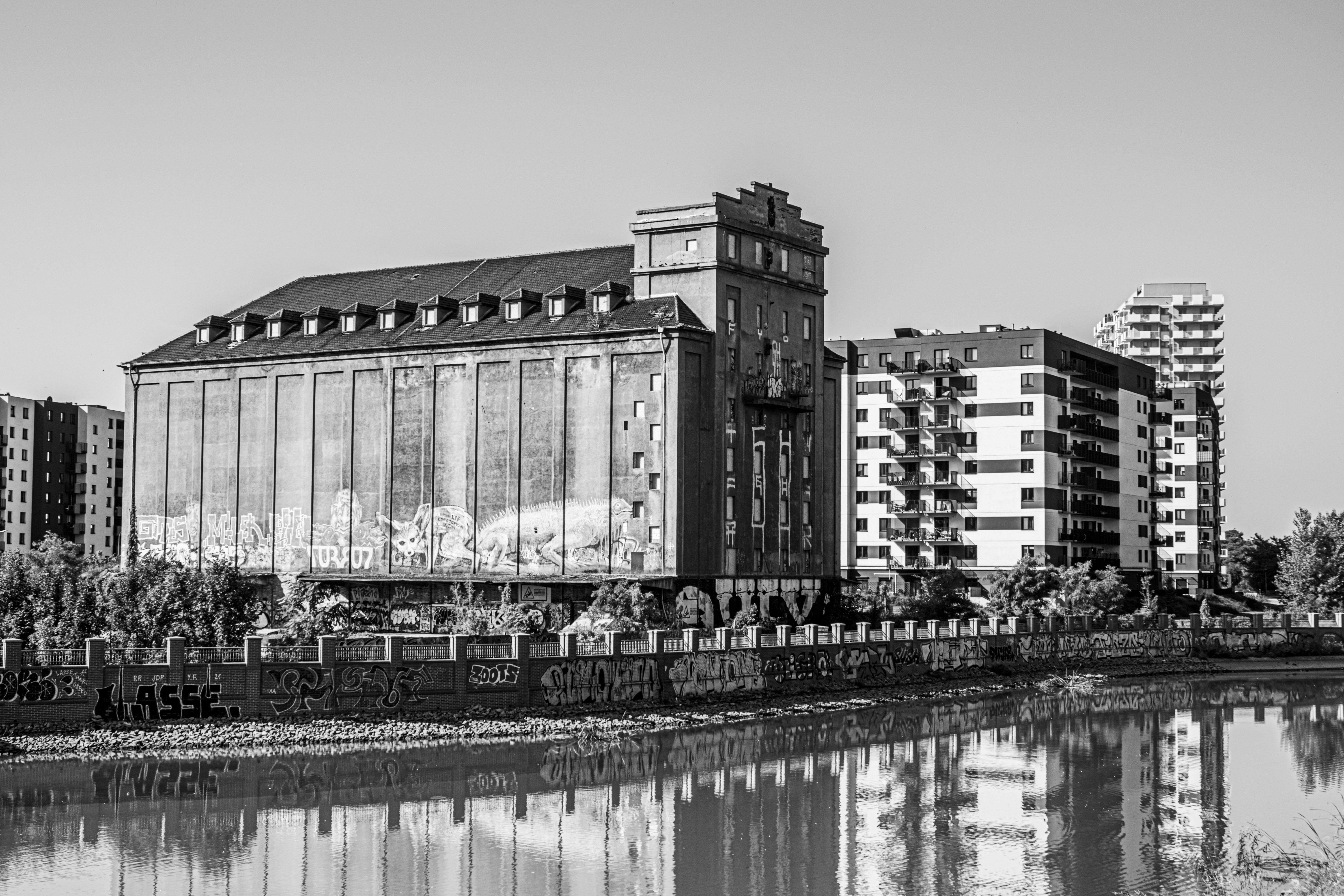Historic Industrial Building by a Riverbank · Free Stock Photo