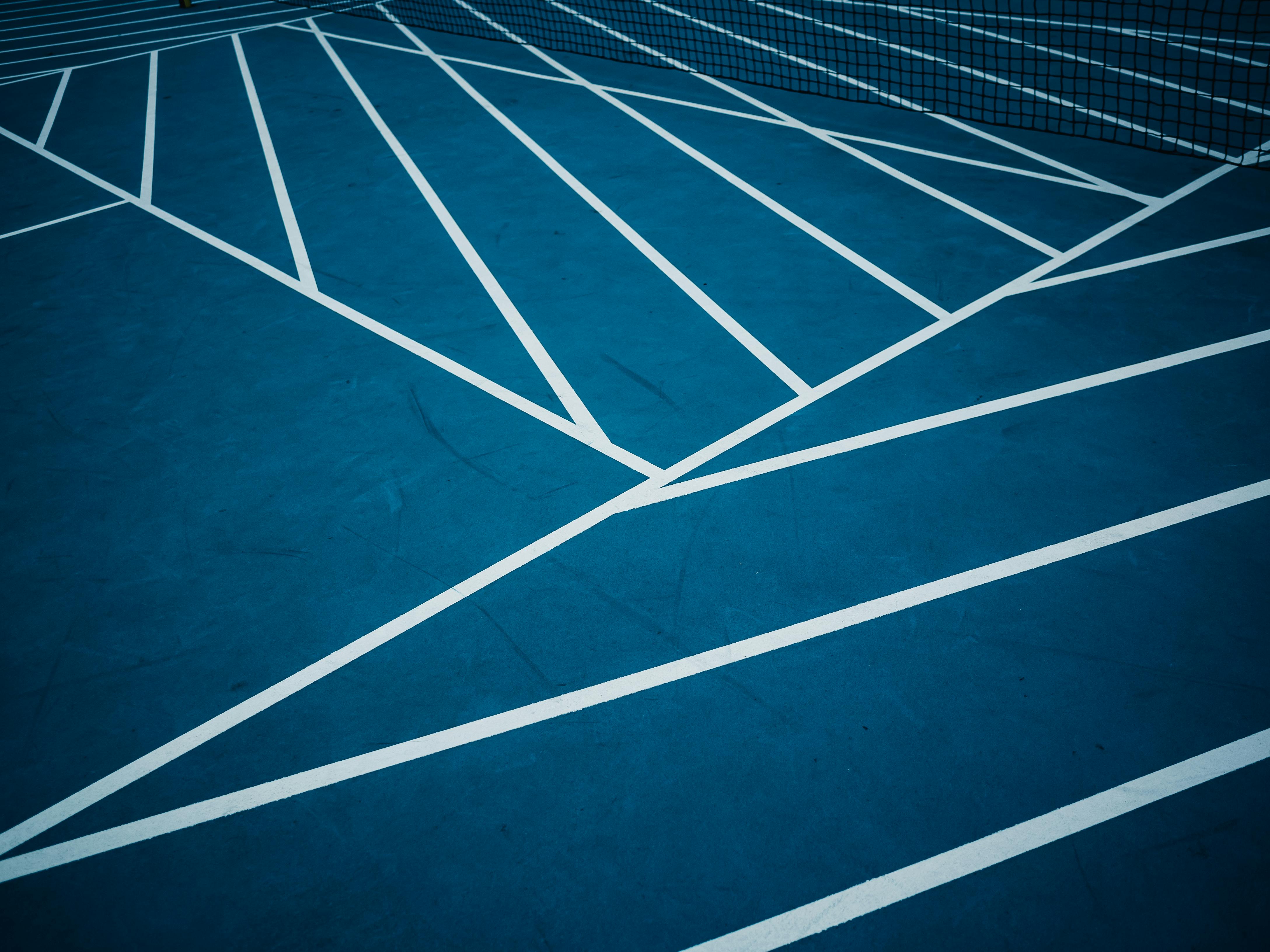 Geometric Patterns on Blue Tennis Court · Free Stock Photo
