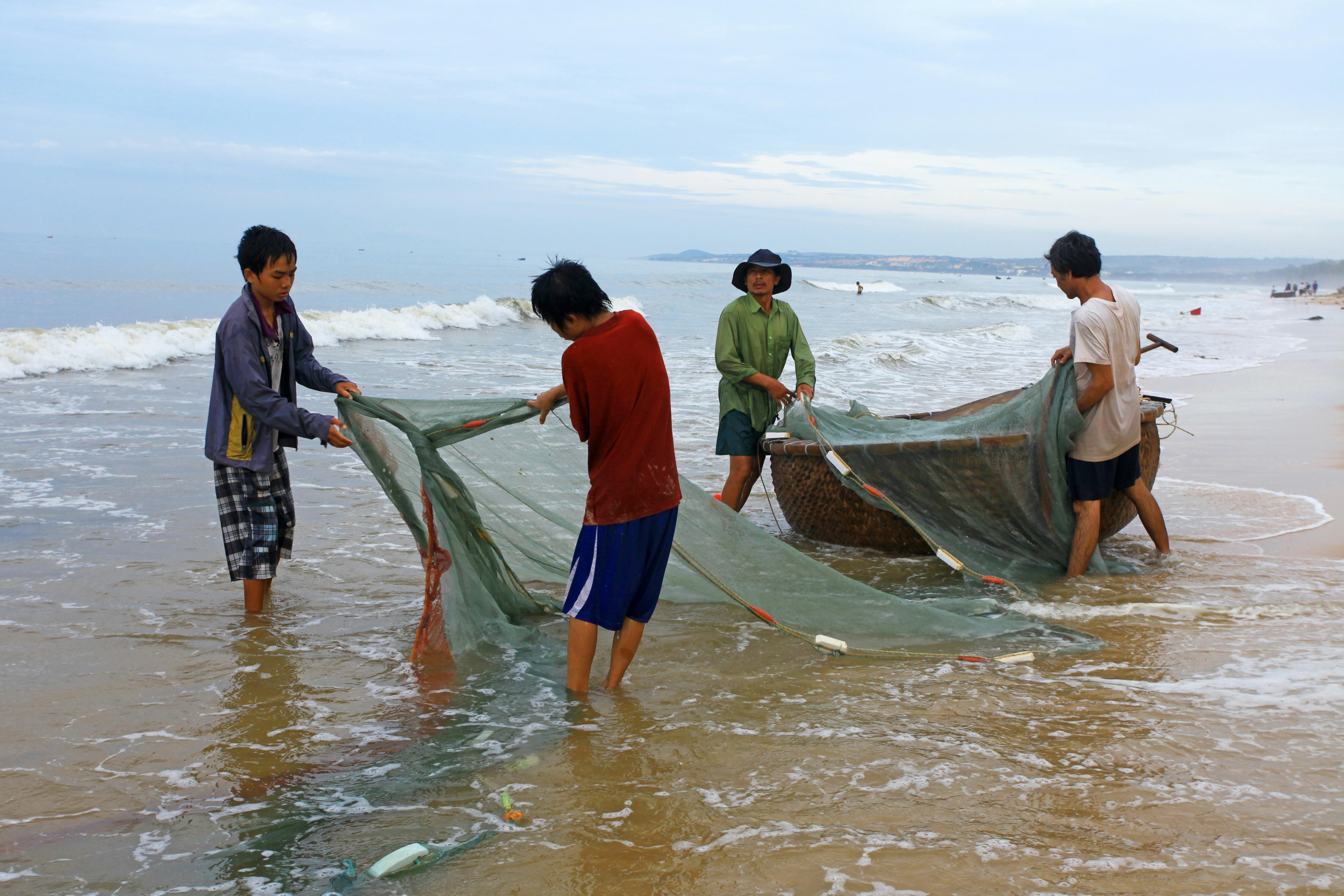 Fishermen Hauling Nets on a Sunny Beach · Free Stock Photo