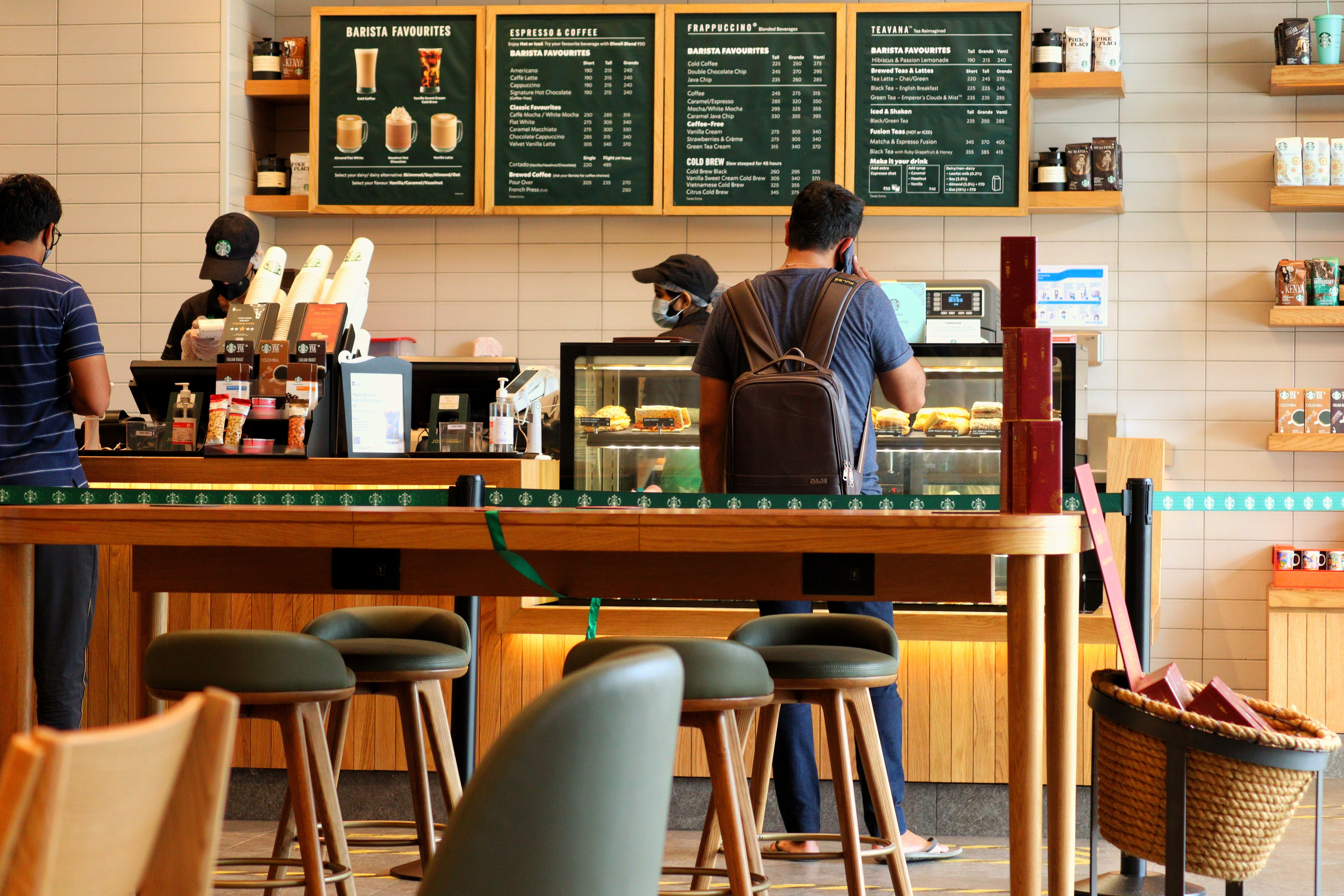 Busy Coffee Shop Counter with Customers · Free Stock Photo