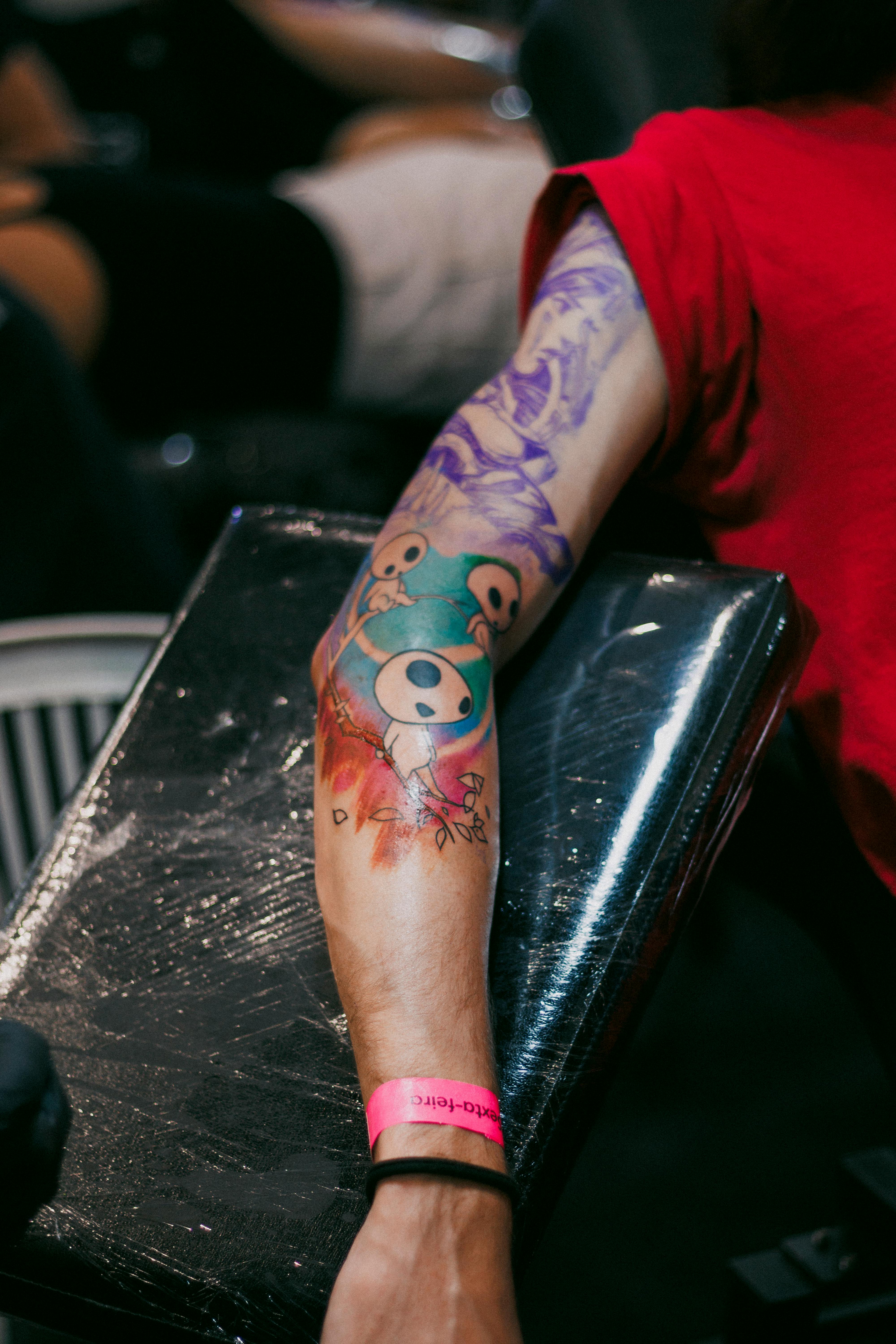 Colorful Arm Tattoo in a Studio Setting · Free Stock Photo