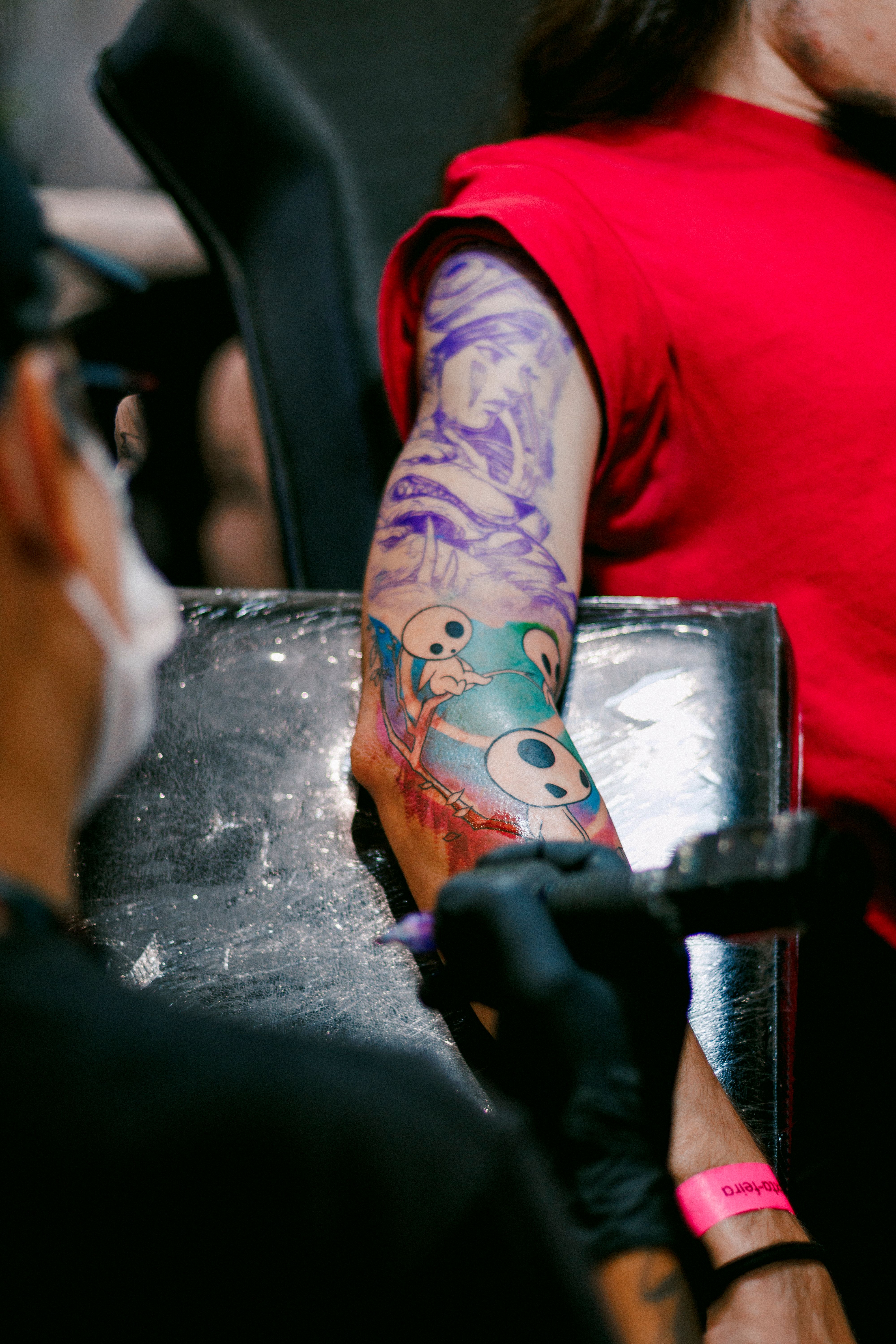 Colorful Arm Tattoo in Progress at Tattoo Studio · Free Stock Photo