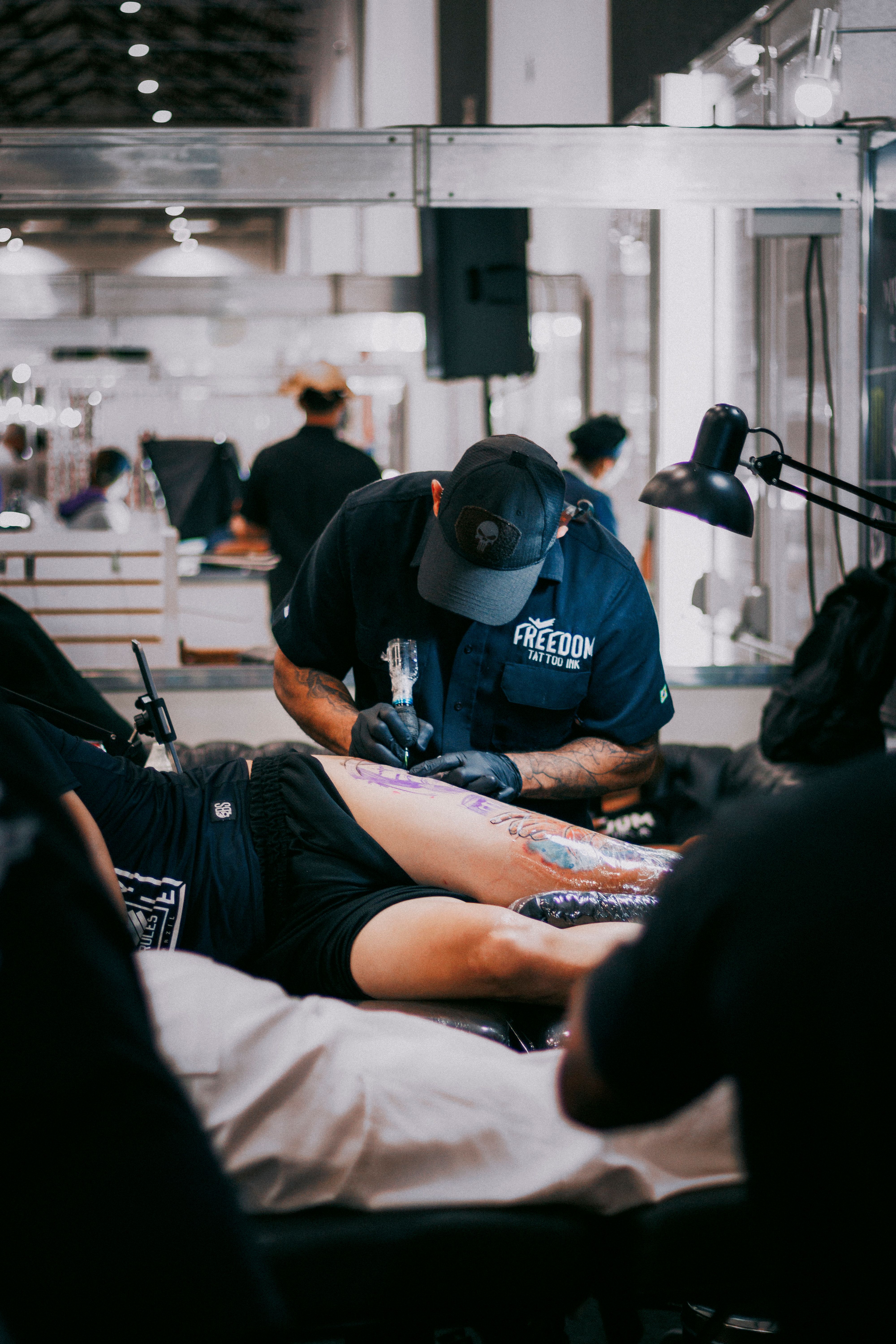 Tattoo Artist Working in a Modern Studio · Free Stock Photo
