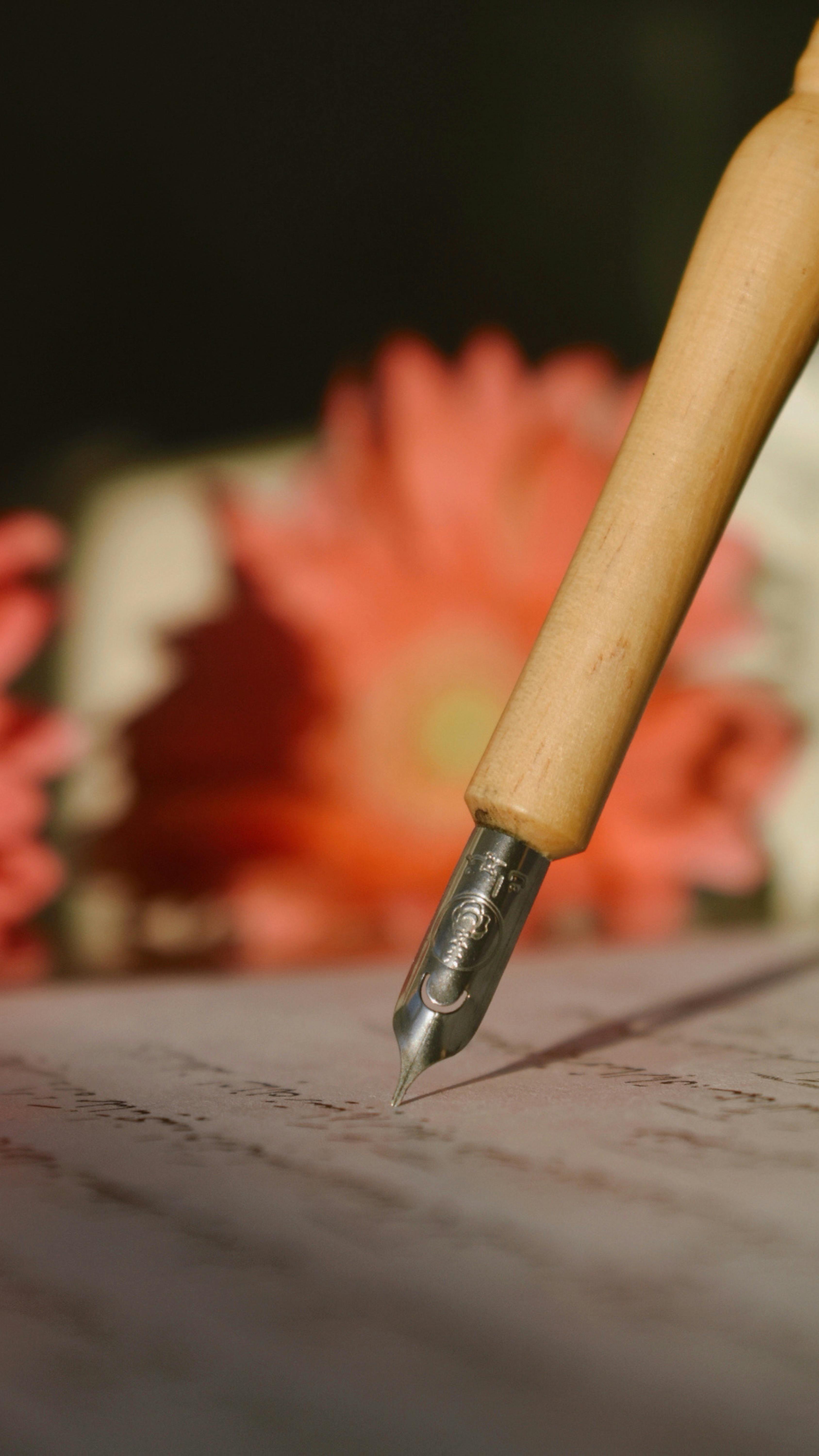 Close-up of Wooden Calligraphy Pen on Paper · Free Stock Photo