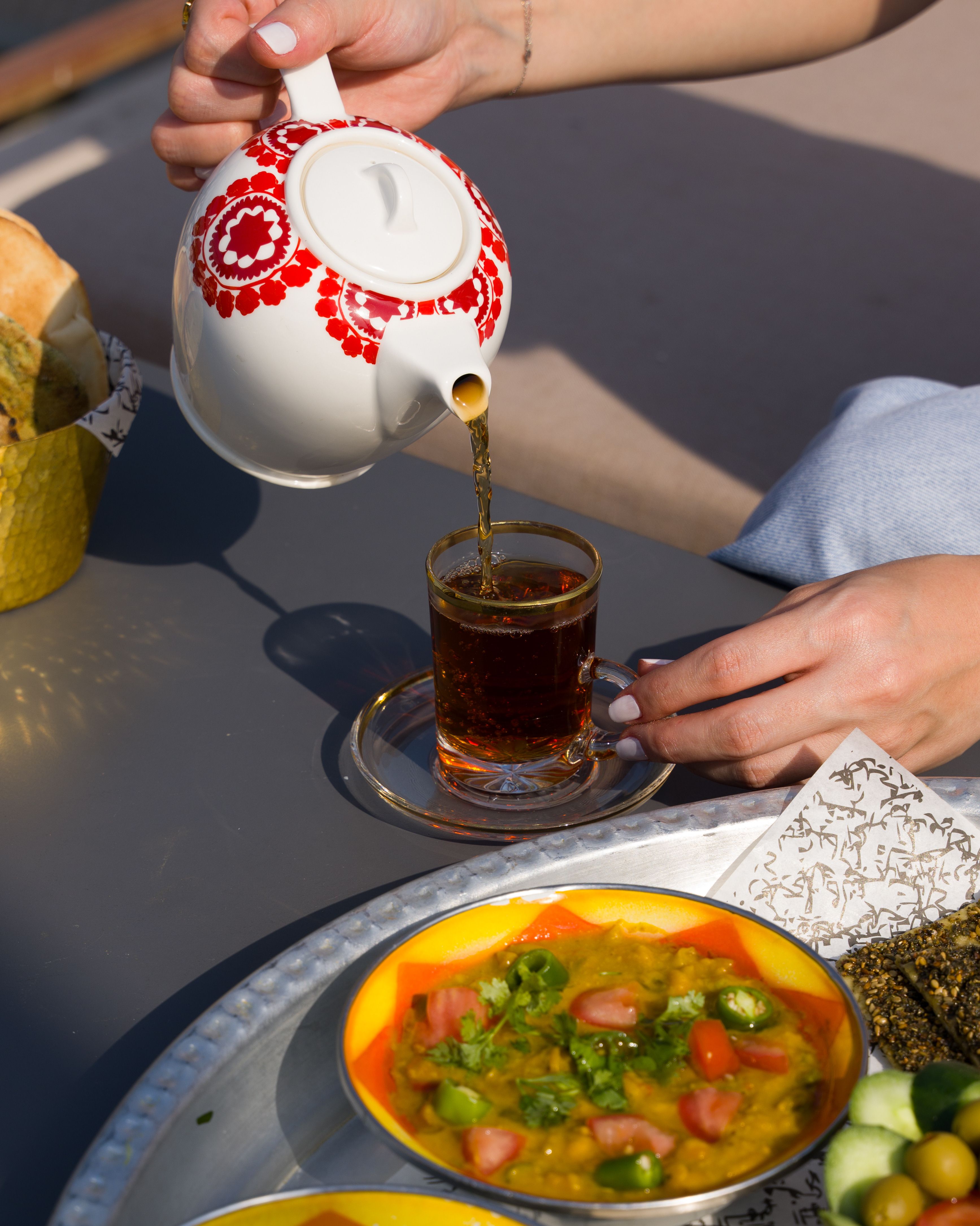 Traditional Tea Pouring with Middle Eastern Dishes · Free Stock Photo