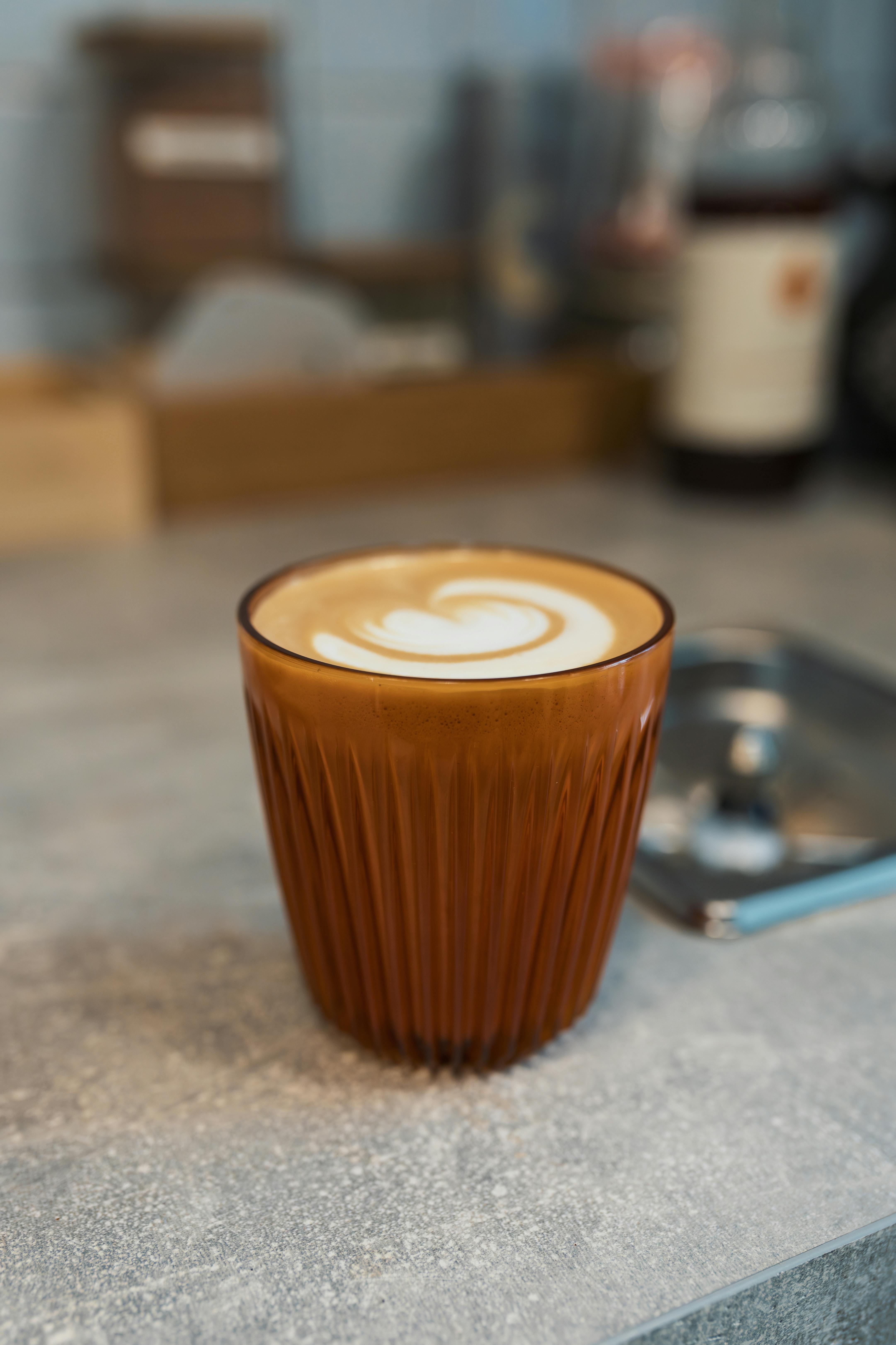 Artistic Latte in a Glass Cup on a Cafe Counter · Free Stock Photo