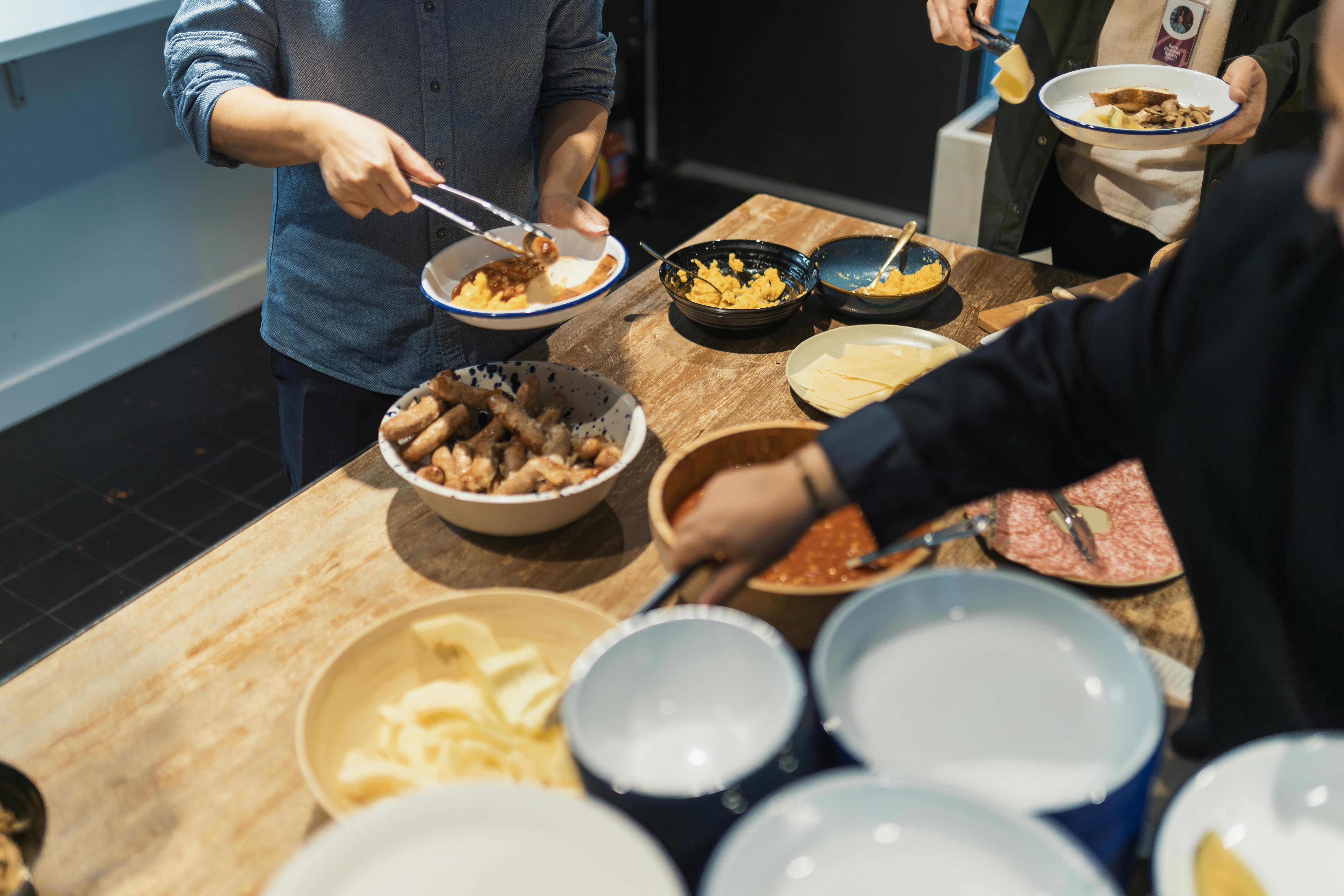 Casual Buffet Gathering with Diverse Dishes · Free Stock Photo