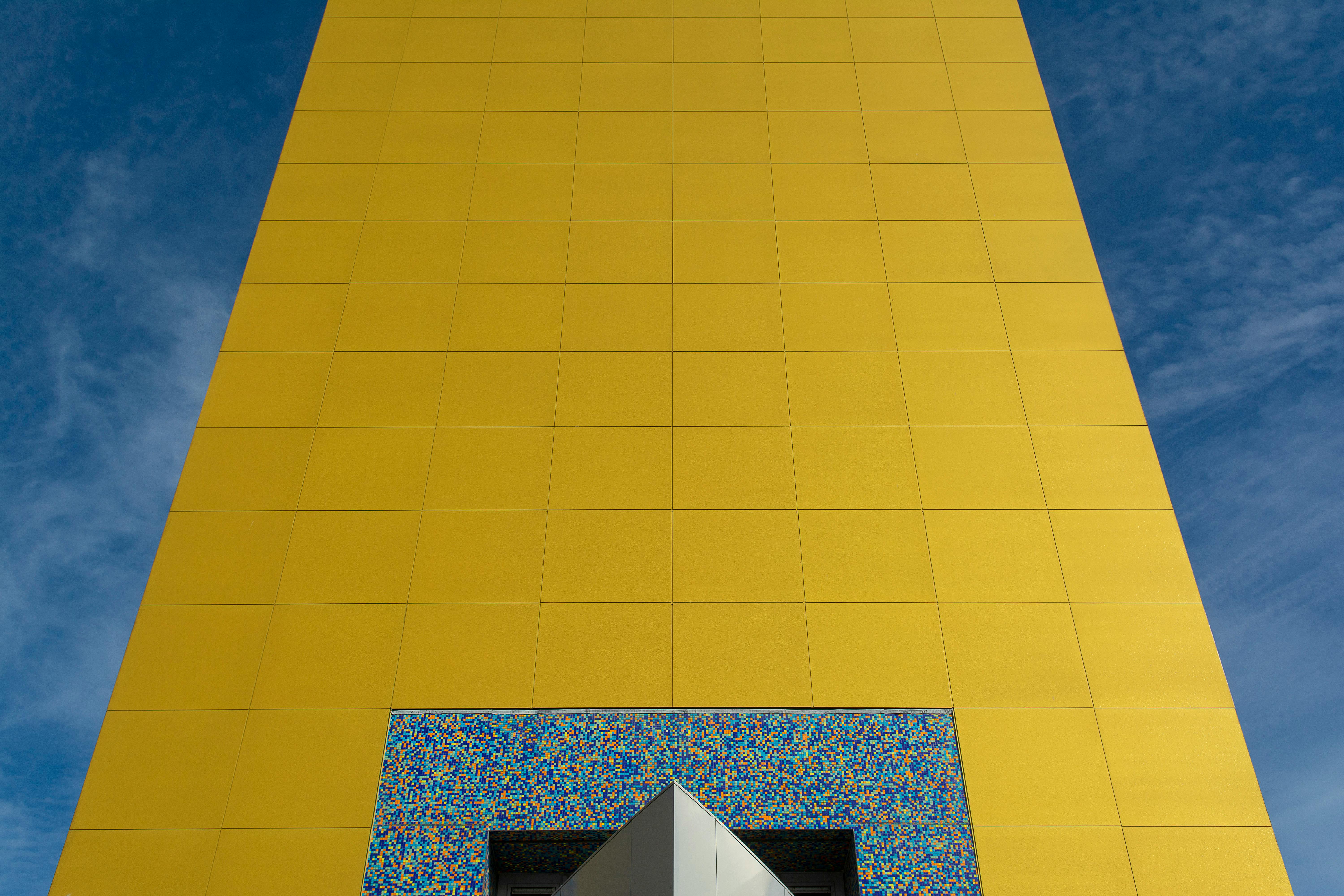 Modern Yellow Building Against Blue Sky · Free Stock Photo