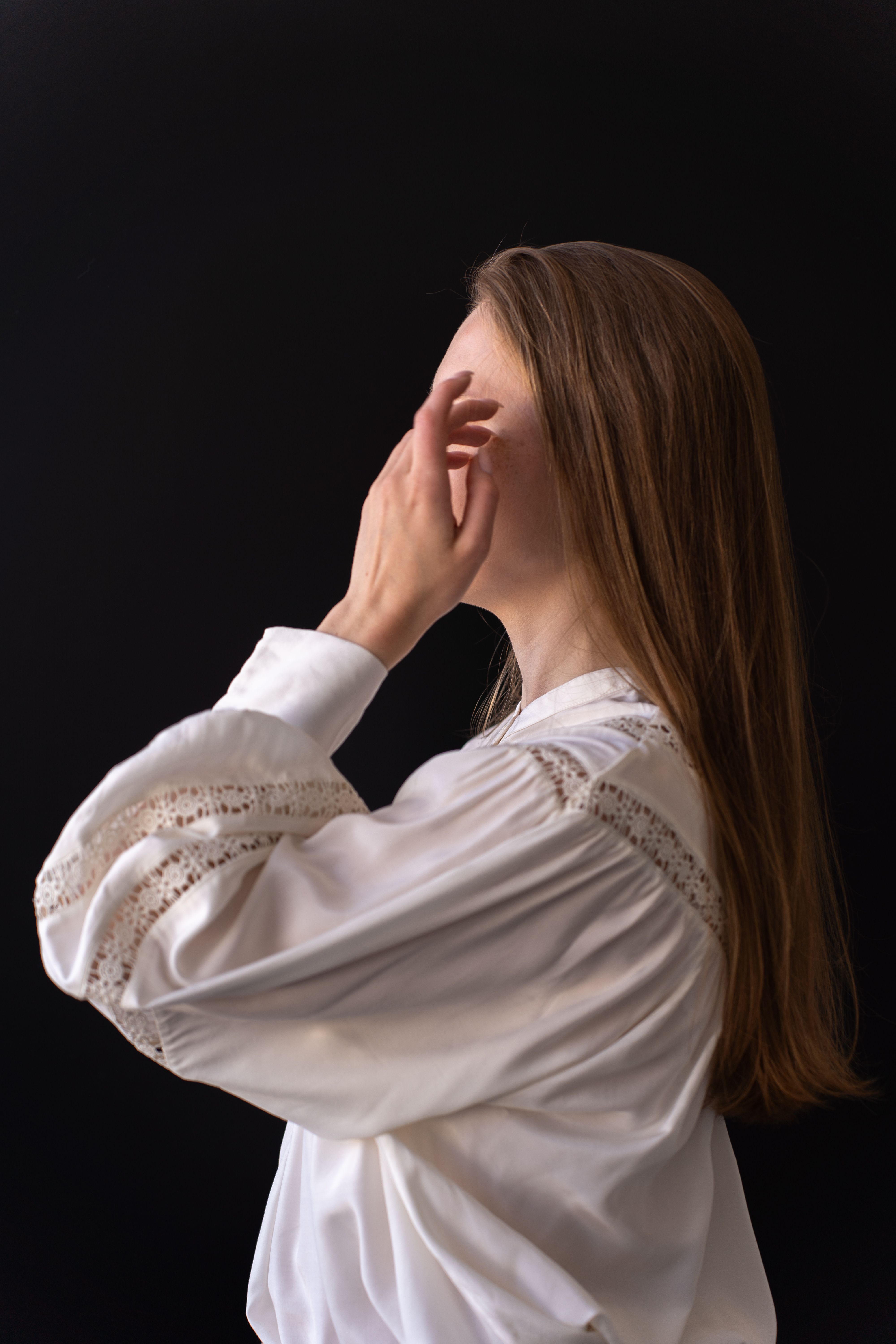 Elegant Side Profile of Woman in White Top · Free Stock Photo