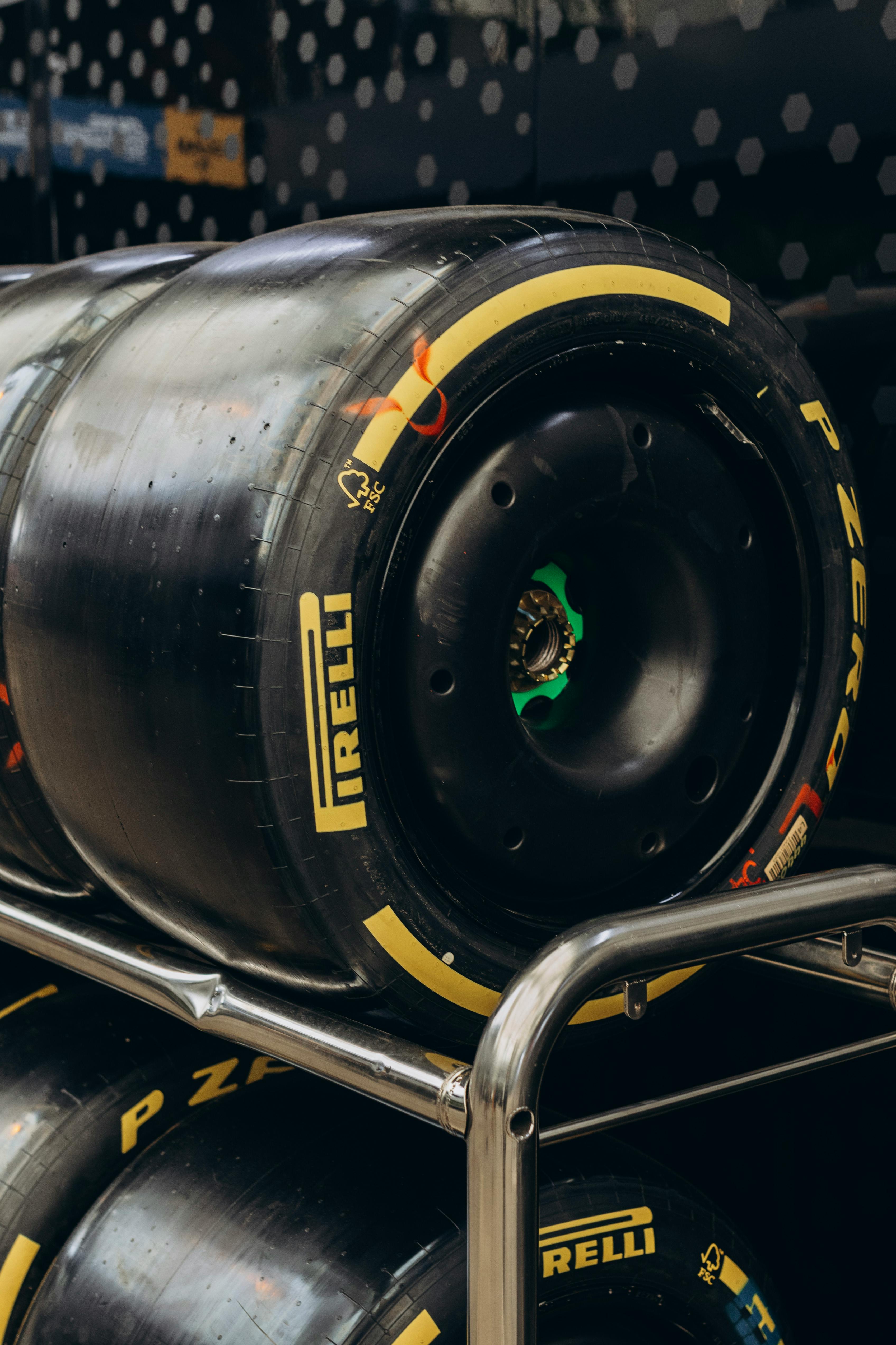 Close-up of Stacked Pirelli Racing Tires Indoors · Free Stock Photo