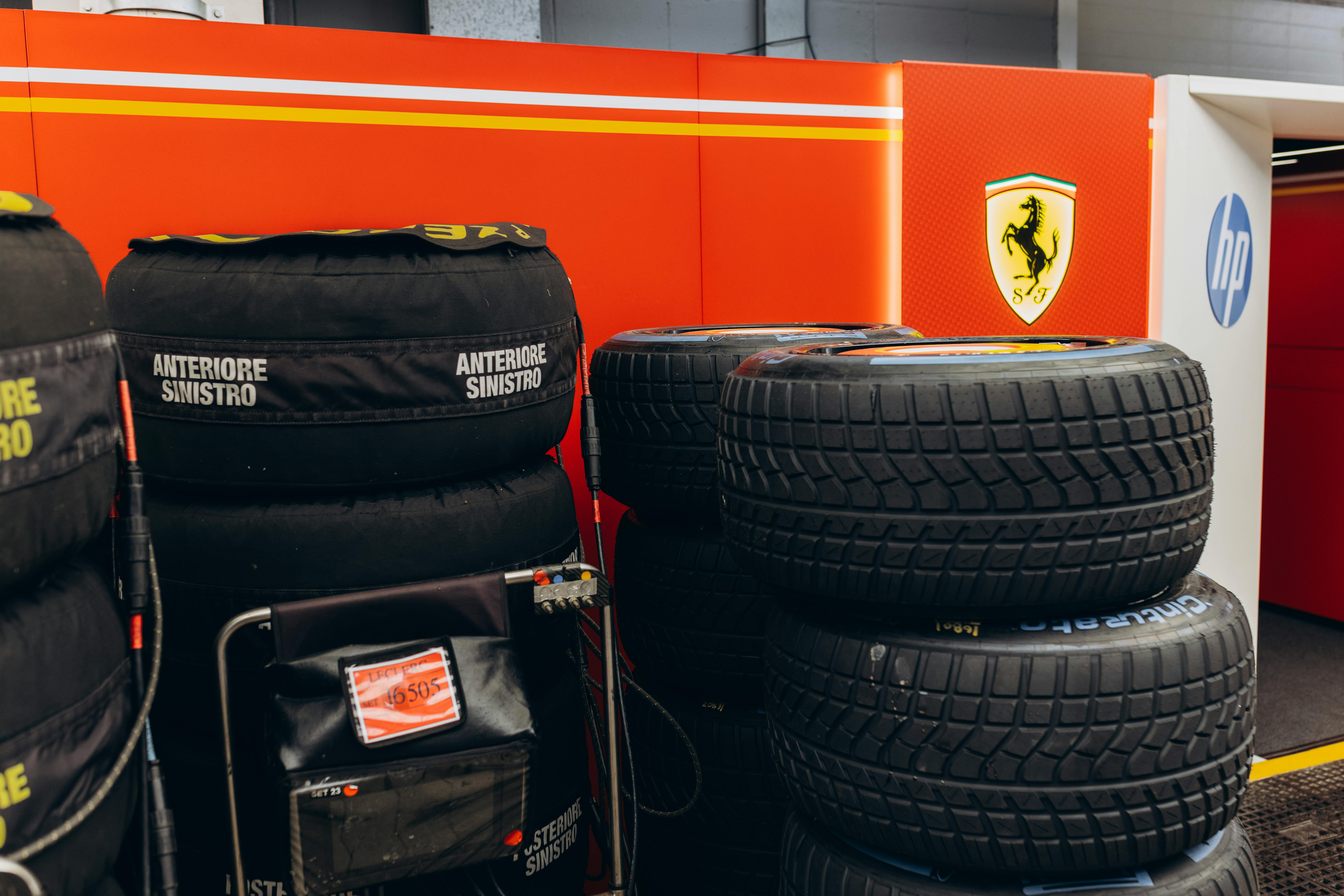 Racing Tires in Ferrari Garage Setup · Free Stock Photo