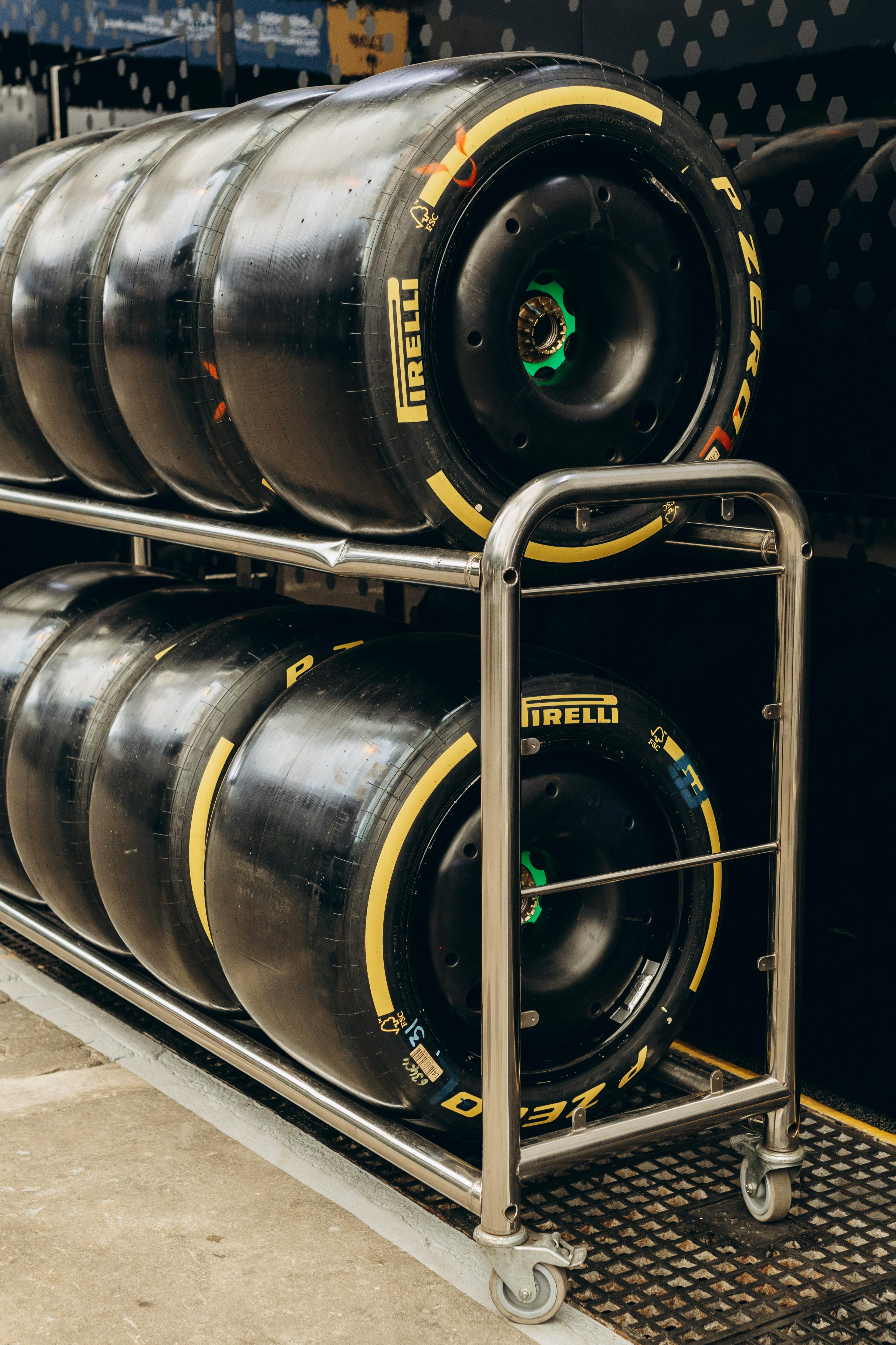 Stacked Racing Tires in Garage Environment · Free Stock Photo