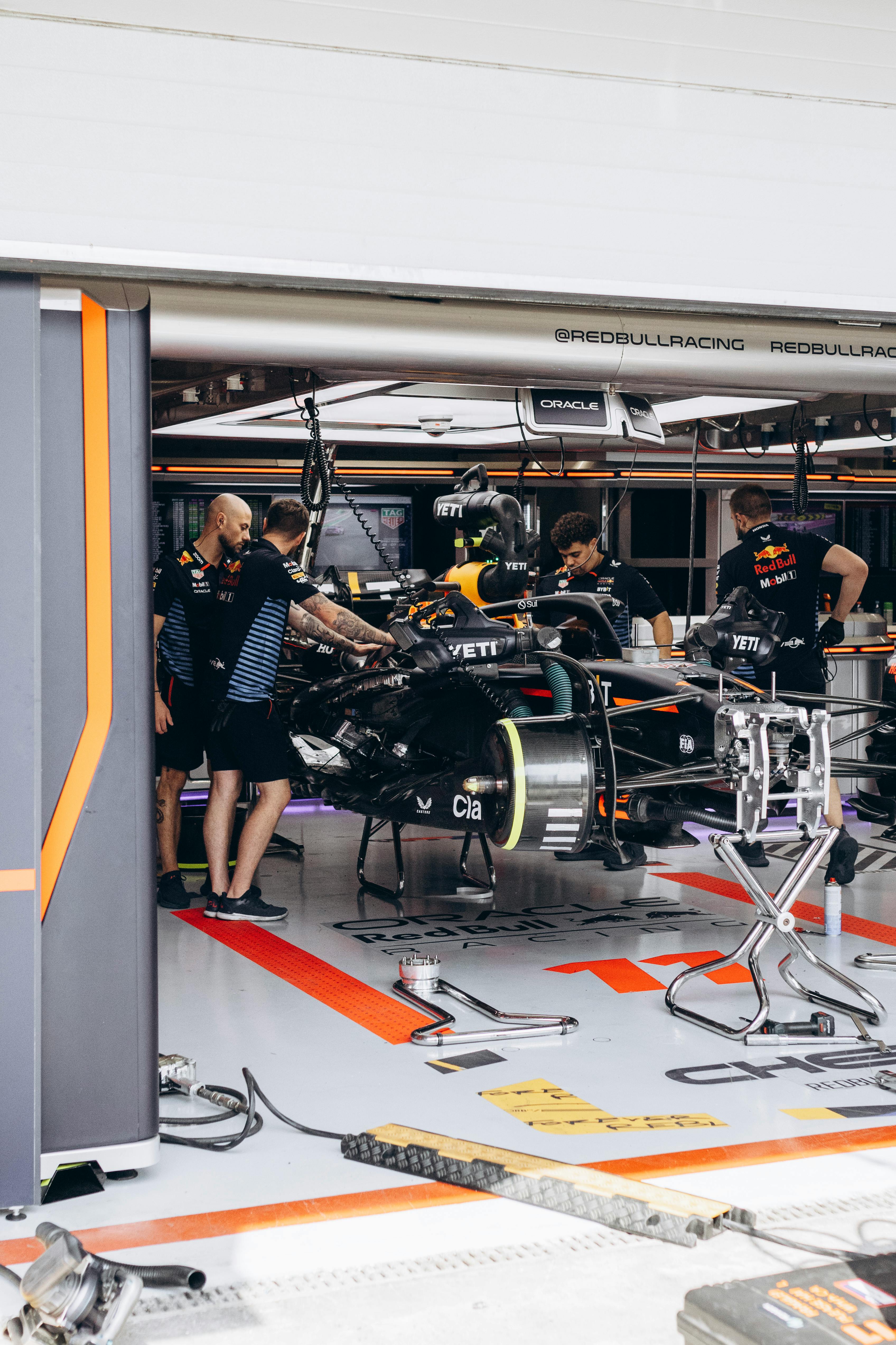 Mechanics Working in Formula 1 Garage · Free Stock Photo