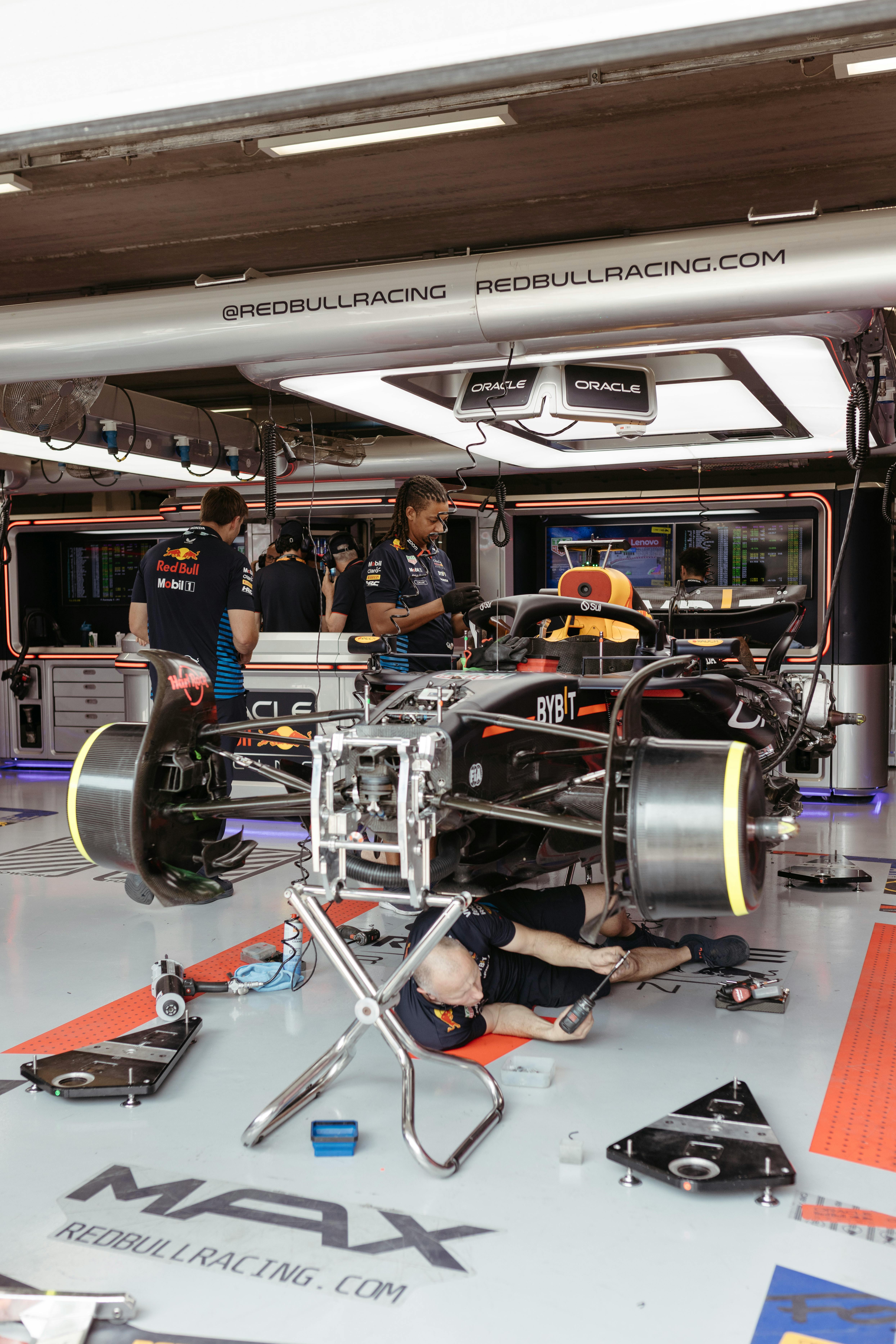 F1 Car Maintenance in Red Bull Racing Garage · Free Stock Photo