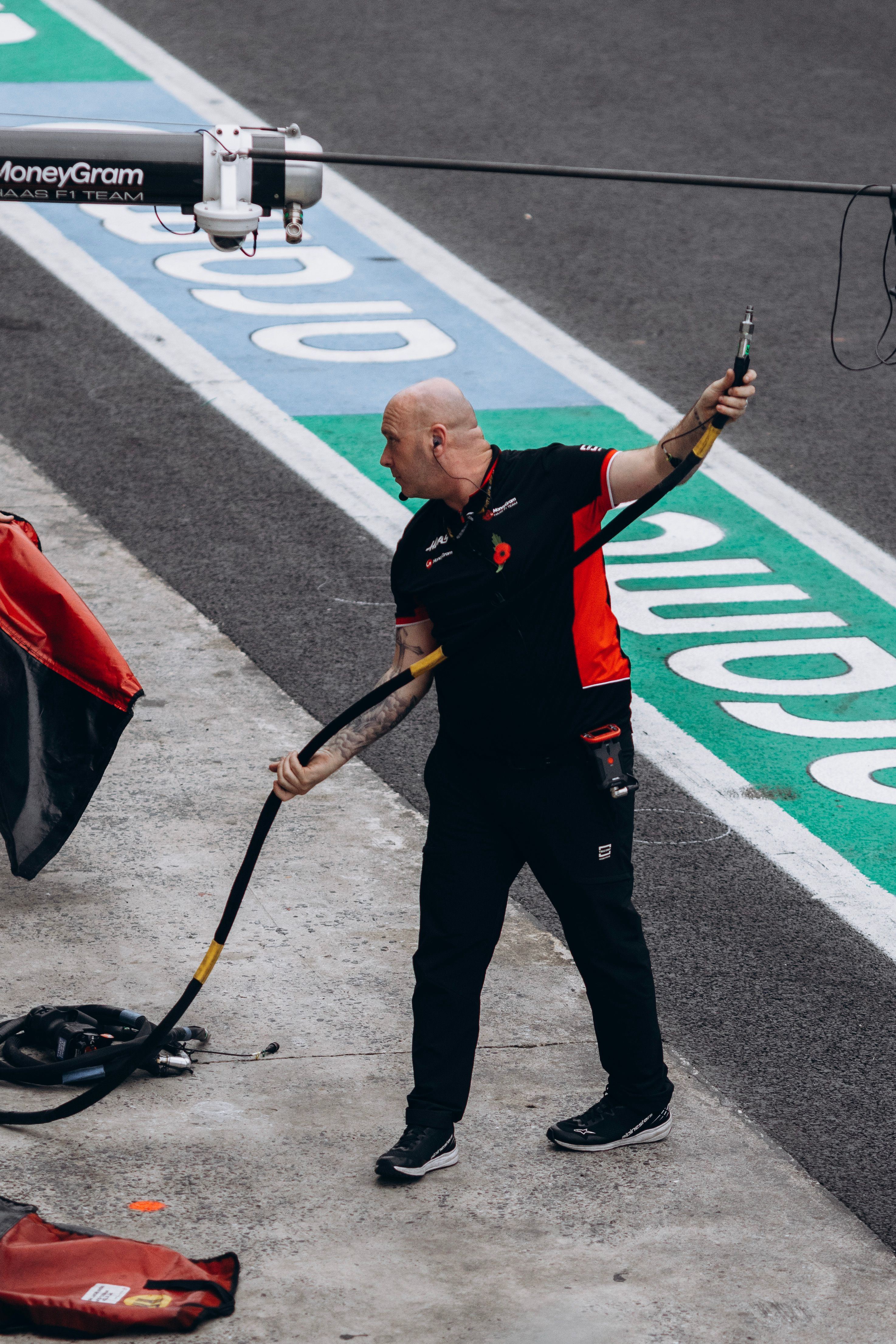 Pit Crew Member Preparing for Race Action · Free Stock Photo