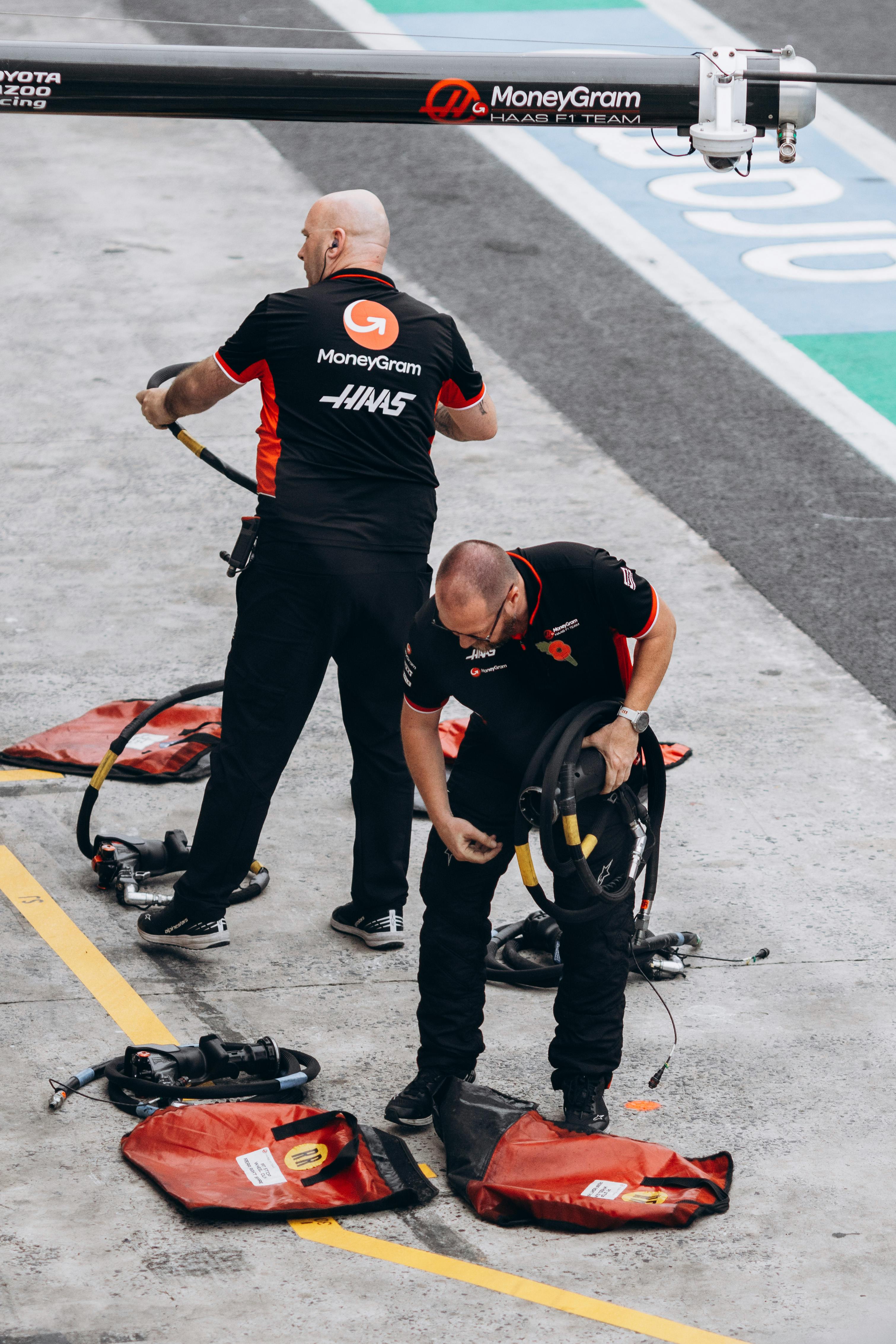 Formula 1 Pit Crew Preparing for Action · Free Stock Photo