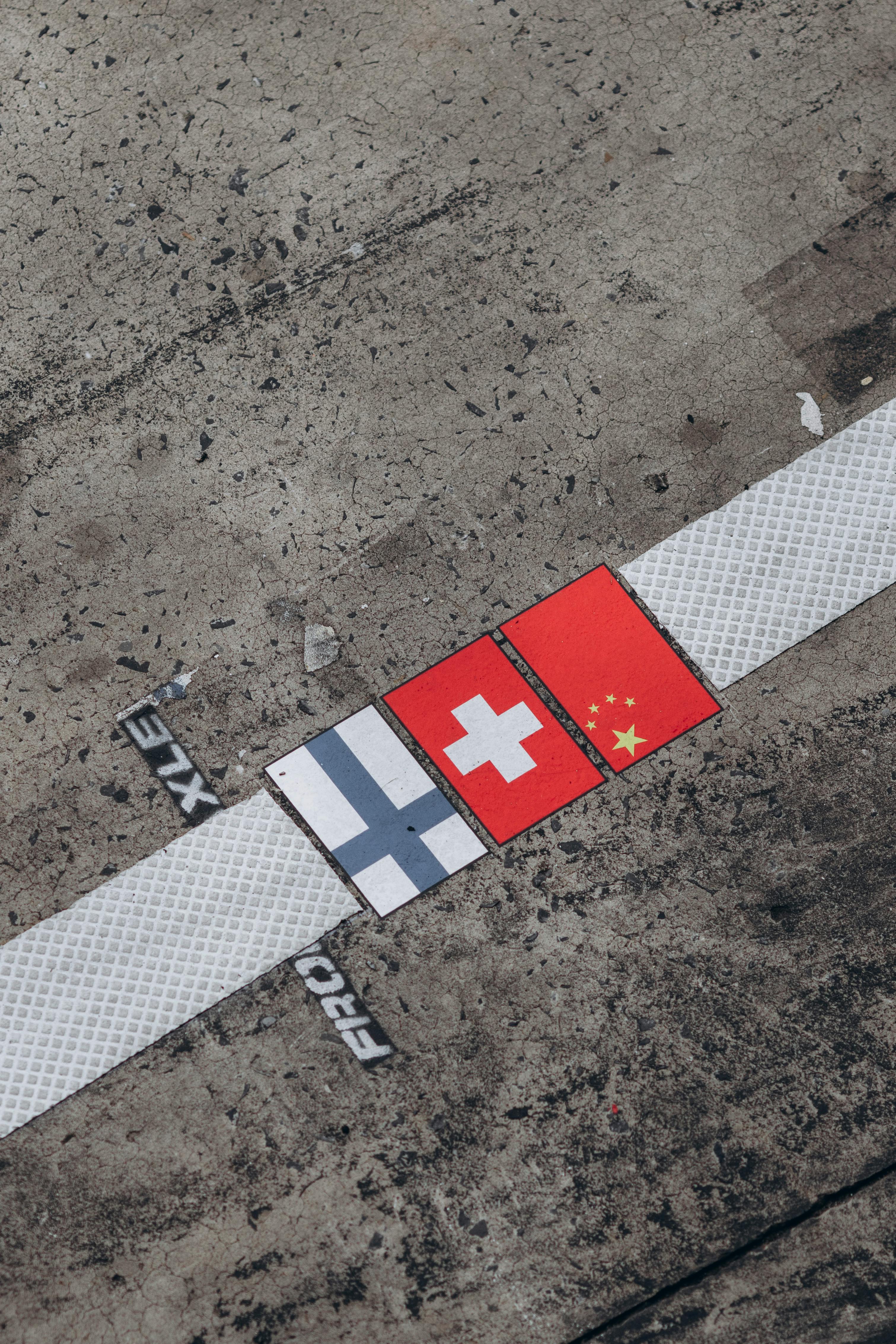 Country Flag Symbols on Urban Pavement · Free Stock Photo