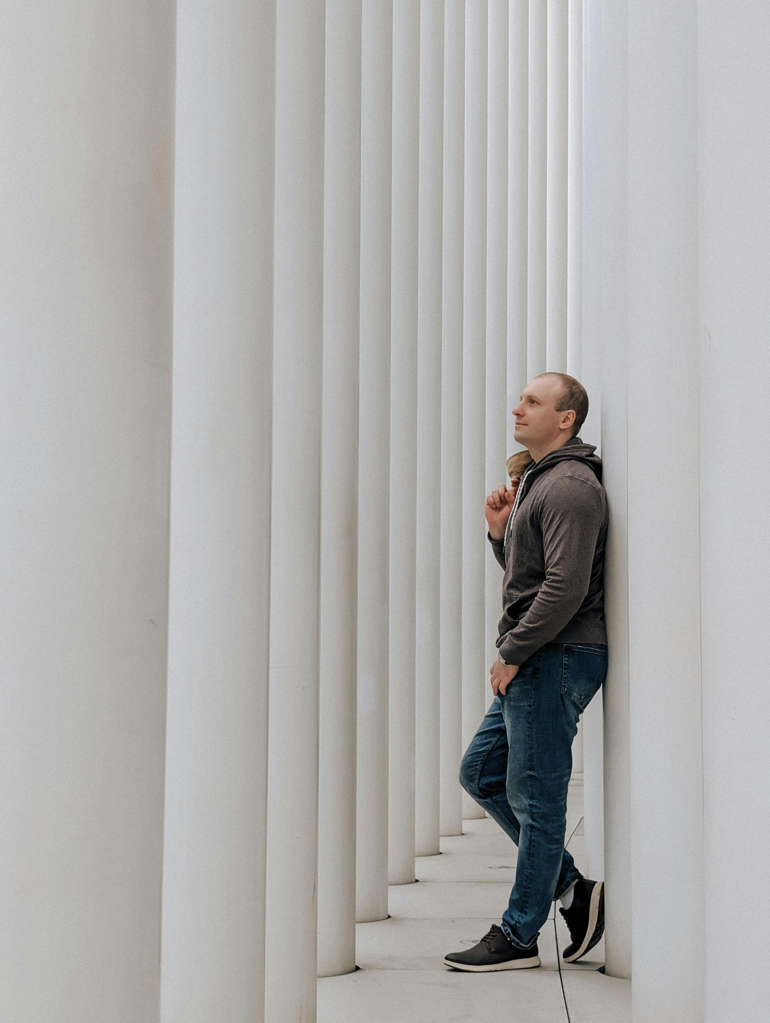 Person Posing Among Tall White Columns in Luxembourg · Free Stock Photo