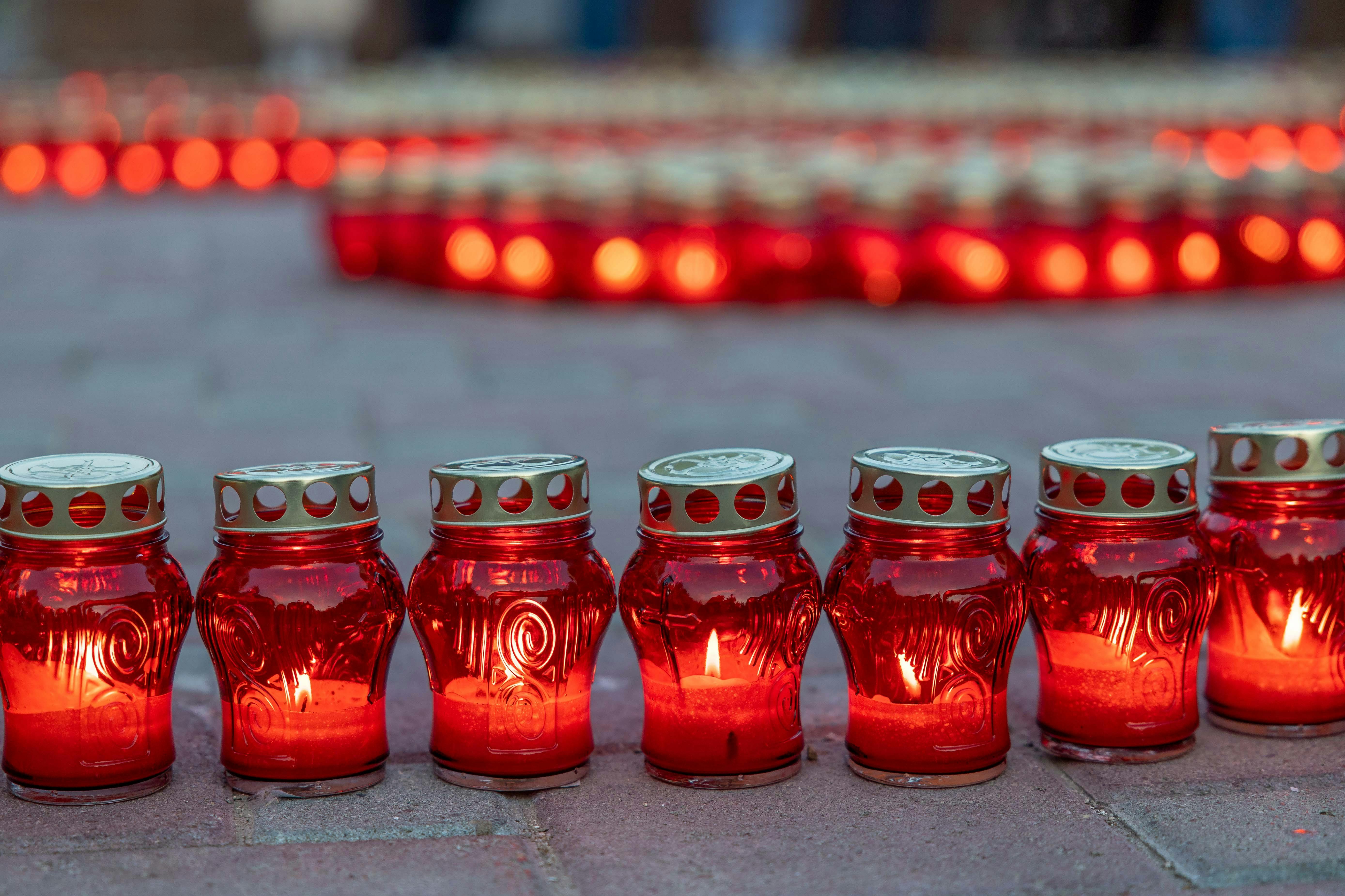 Line of Red Memorial Candles in Twilight · Free Stock Photo