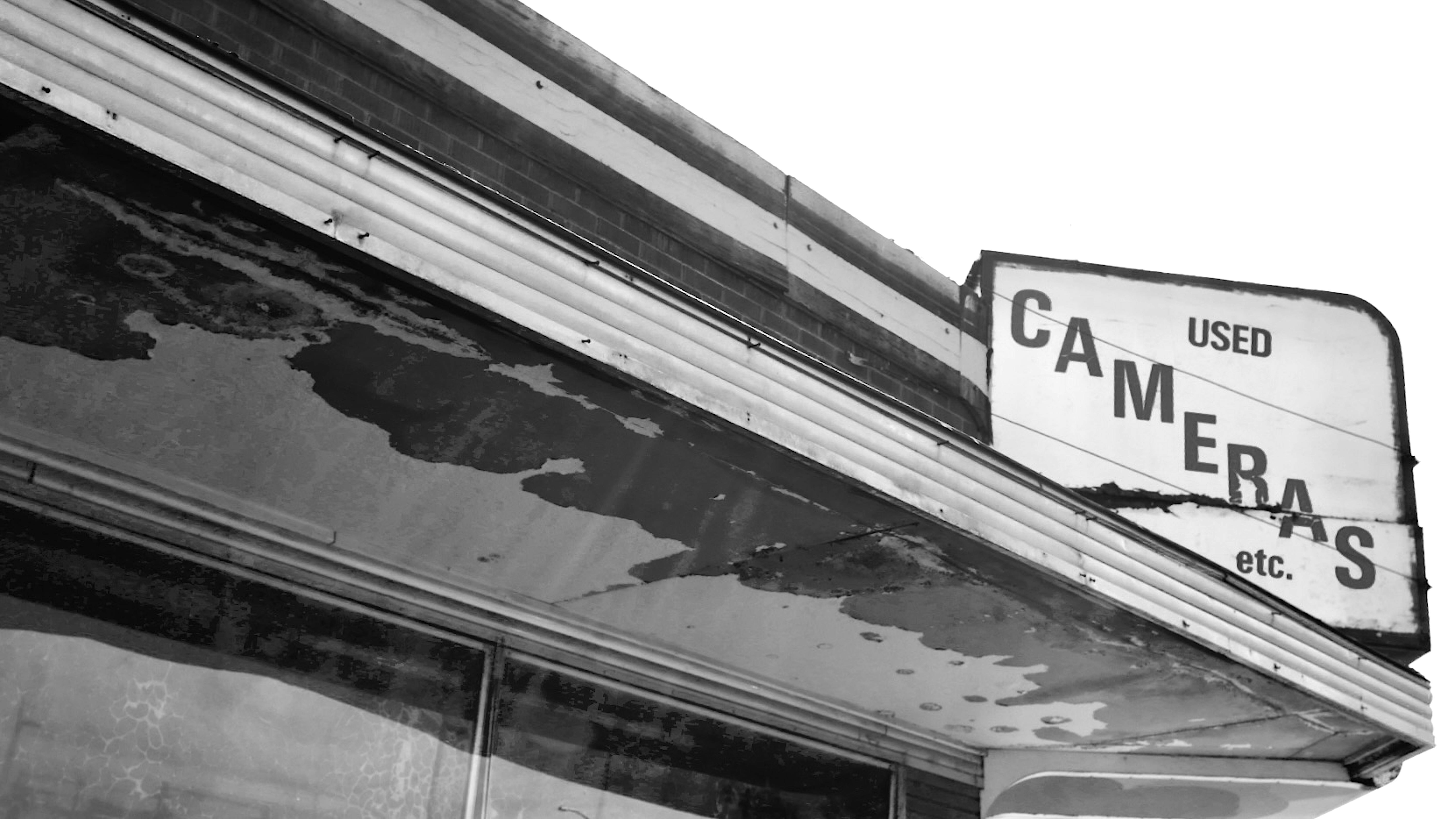 Vintage Used Camera Storefront in Black and White · Free Stock Photo