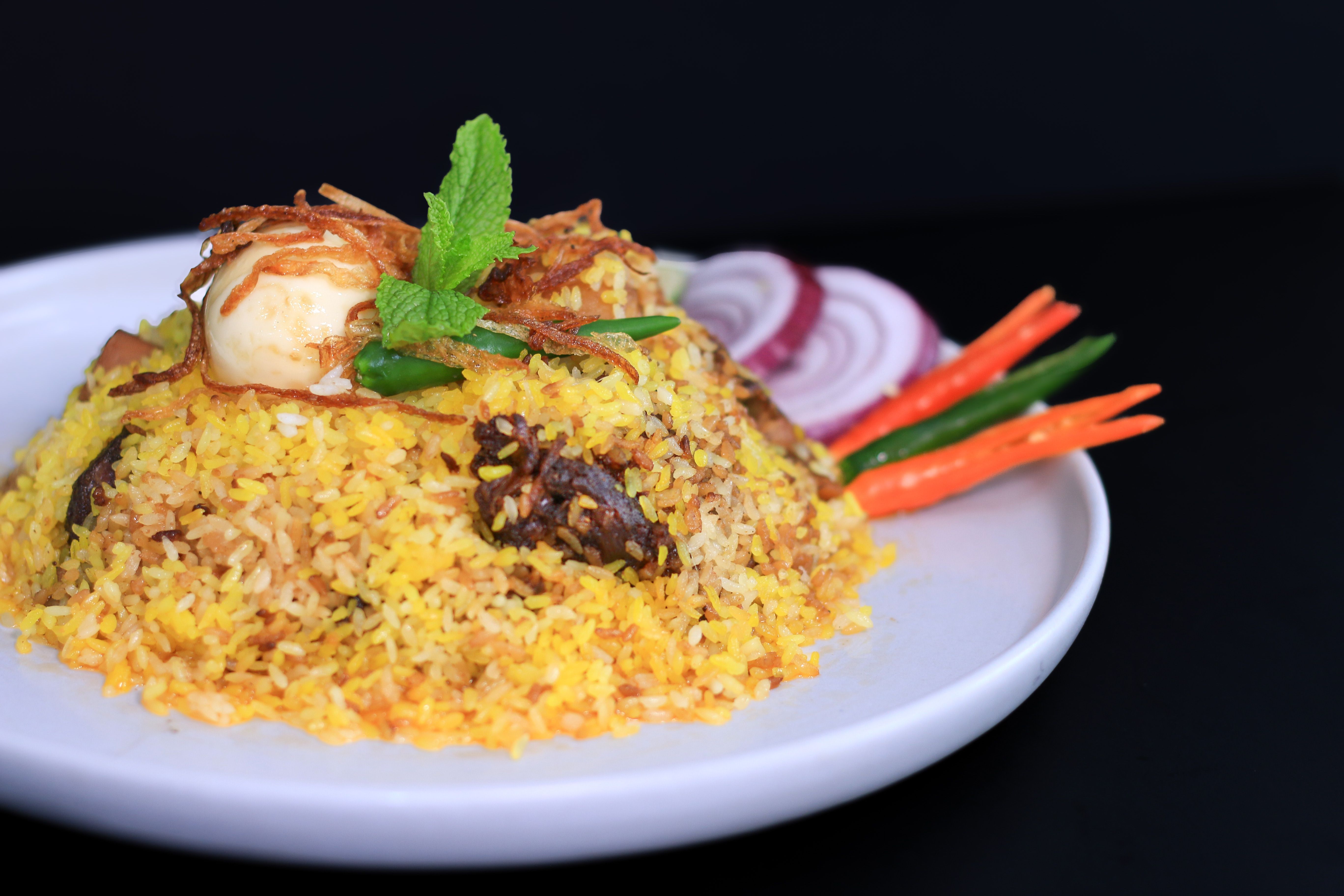 Delicious Indian Biryani with Garnish on Plate · Free Stock Photo