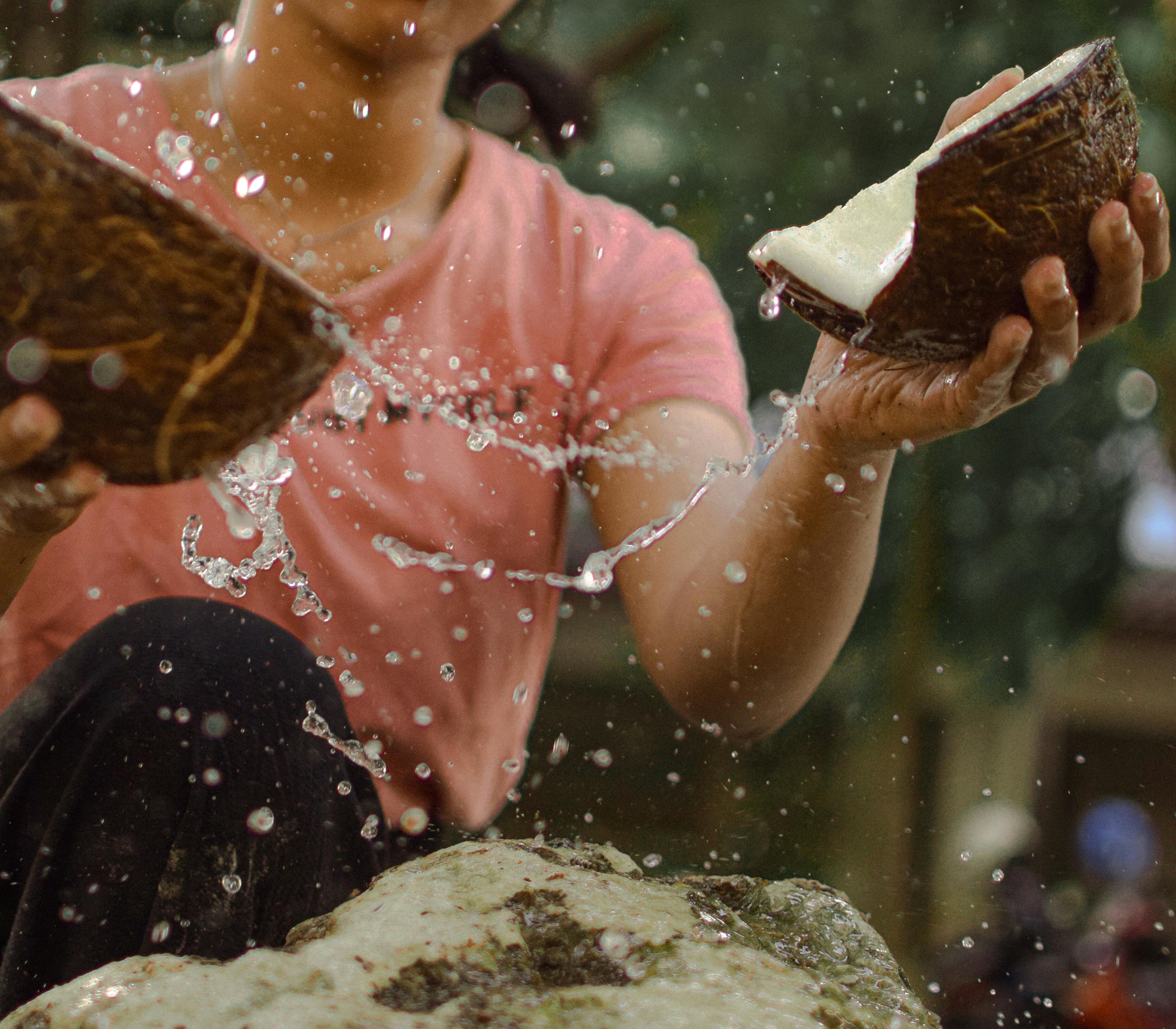 Photo Of Woman Cracking Coconut Shells · Free Stock Photo