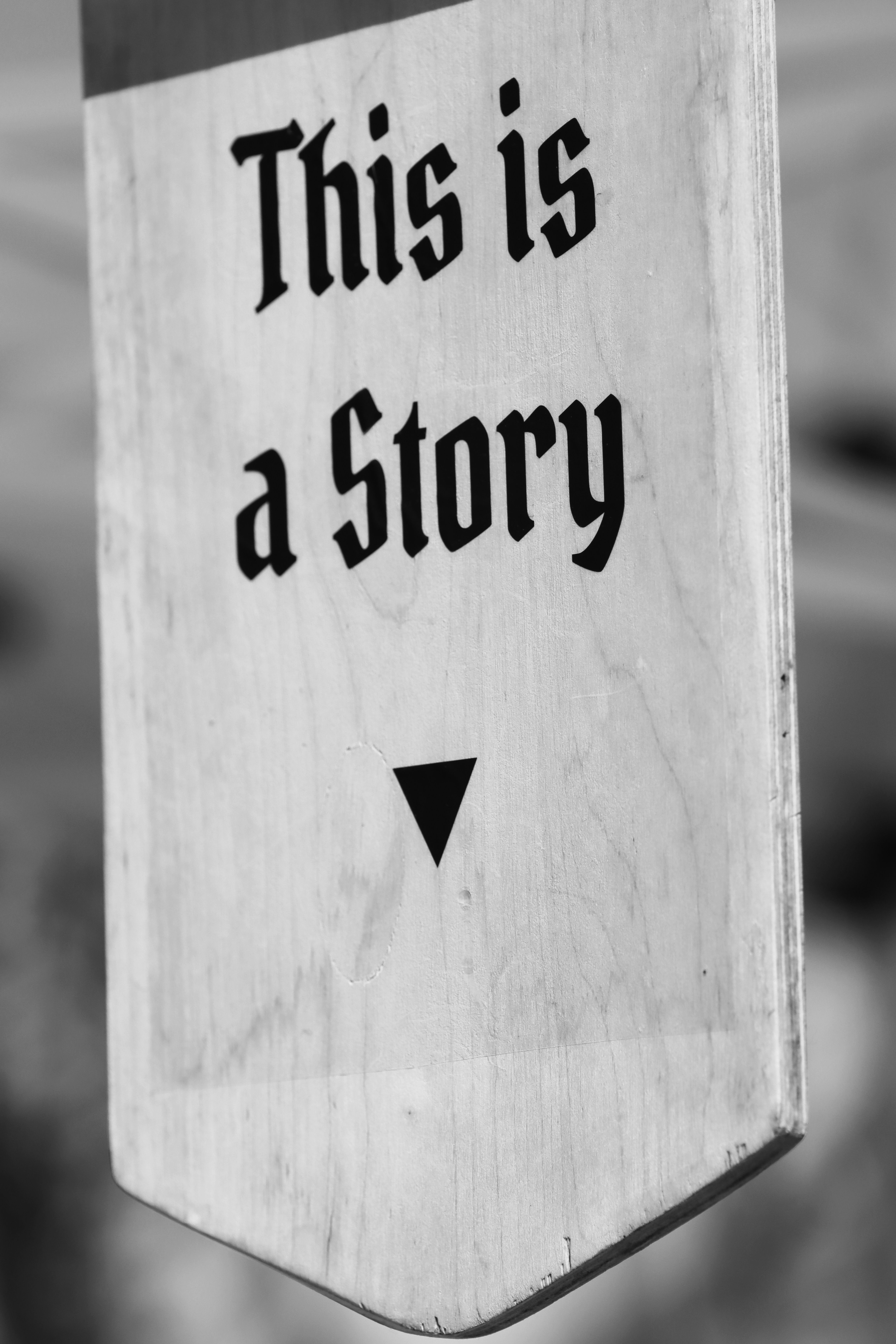 Monochrome Wooden Sign with Text 'This is a Story' · Free Stock Photo