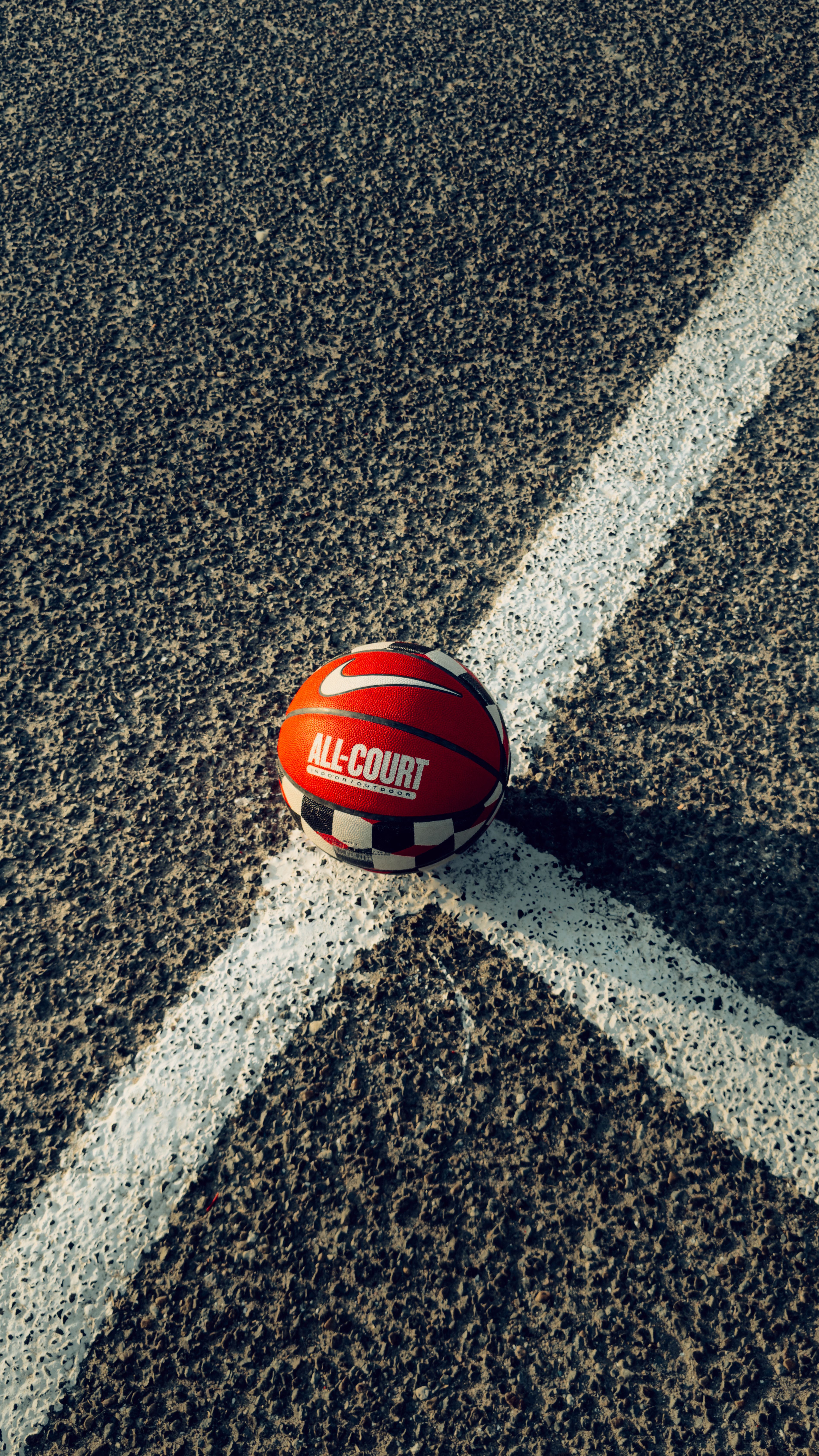 Red Basketball on Outdoor Court Surface · Free Stock Photo