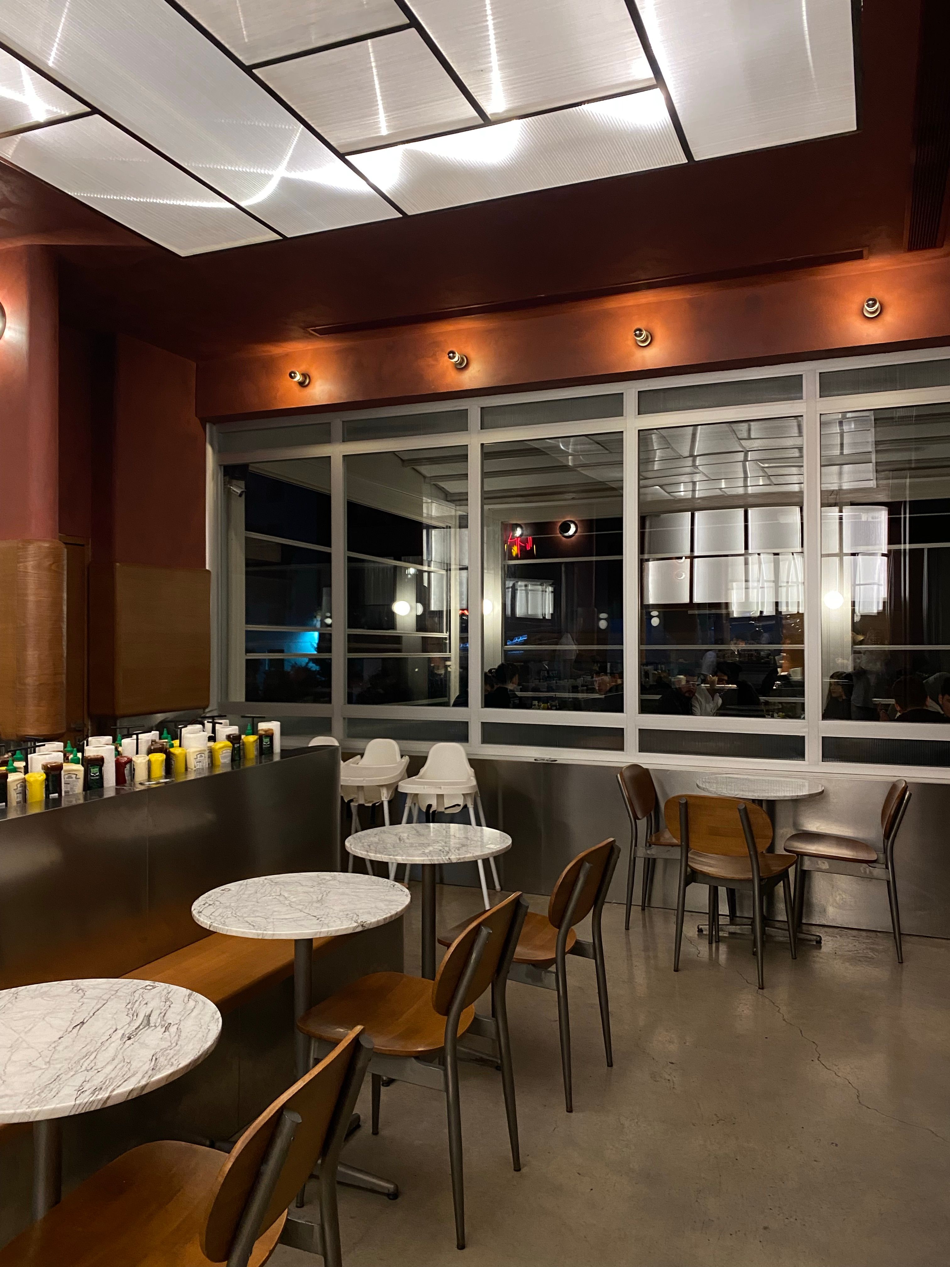 Modern Cafe Interior with Marble Tables at Night · Free Stock Photo