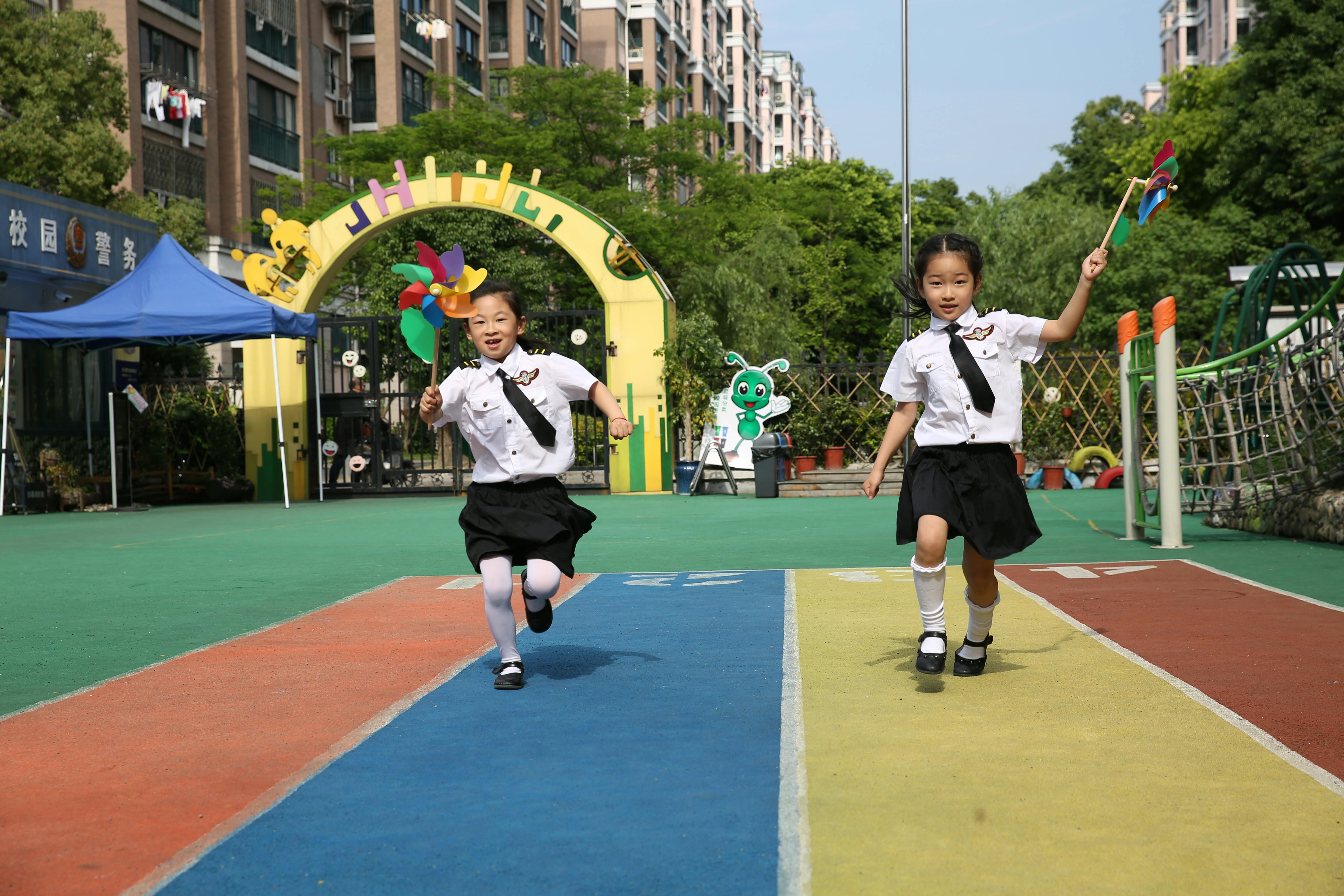 Children Running on Colorful Playground Track · Free Stock Photo