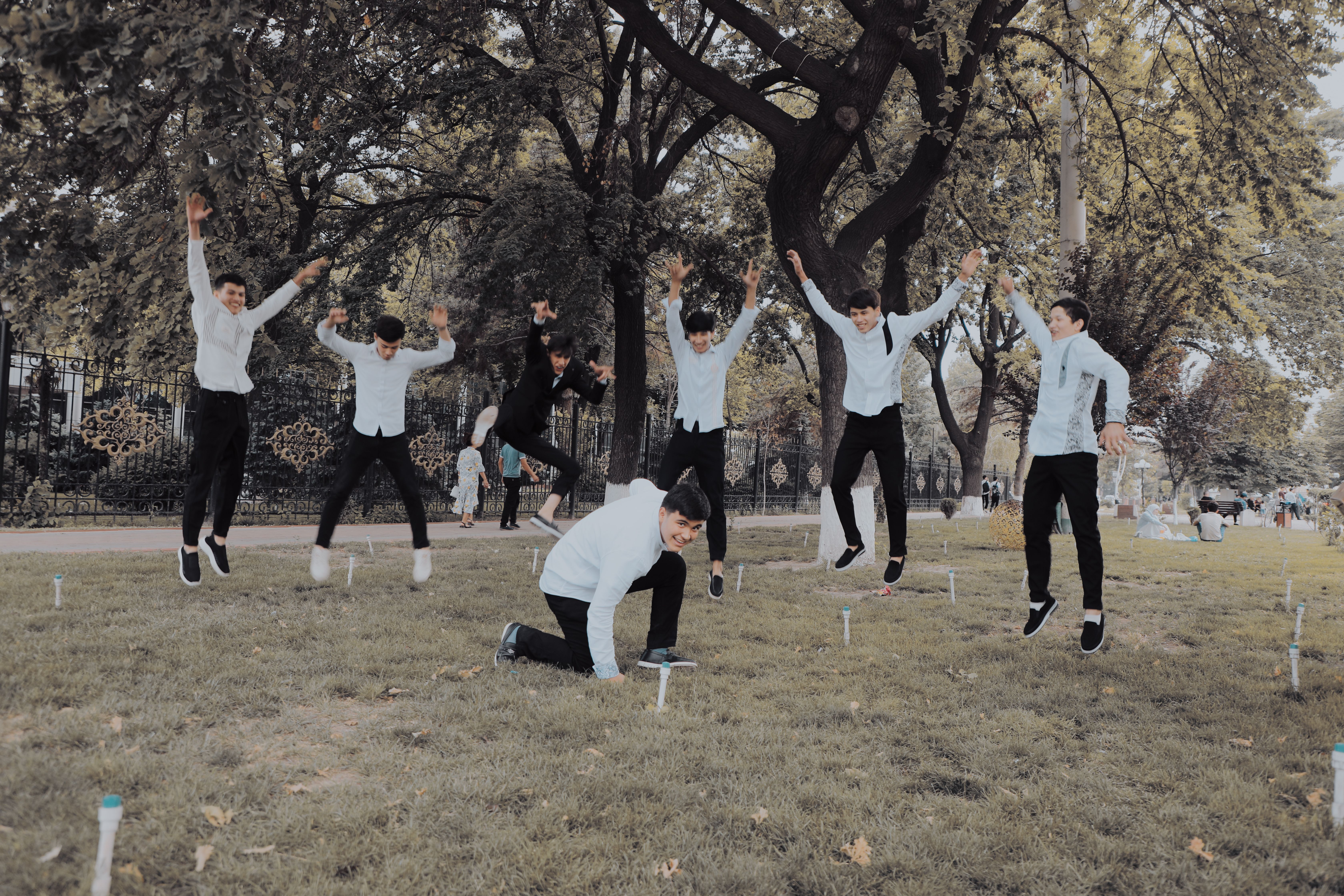 Group of Young Men Jumping Outdoors in Park · Free Stock Photo