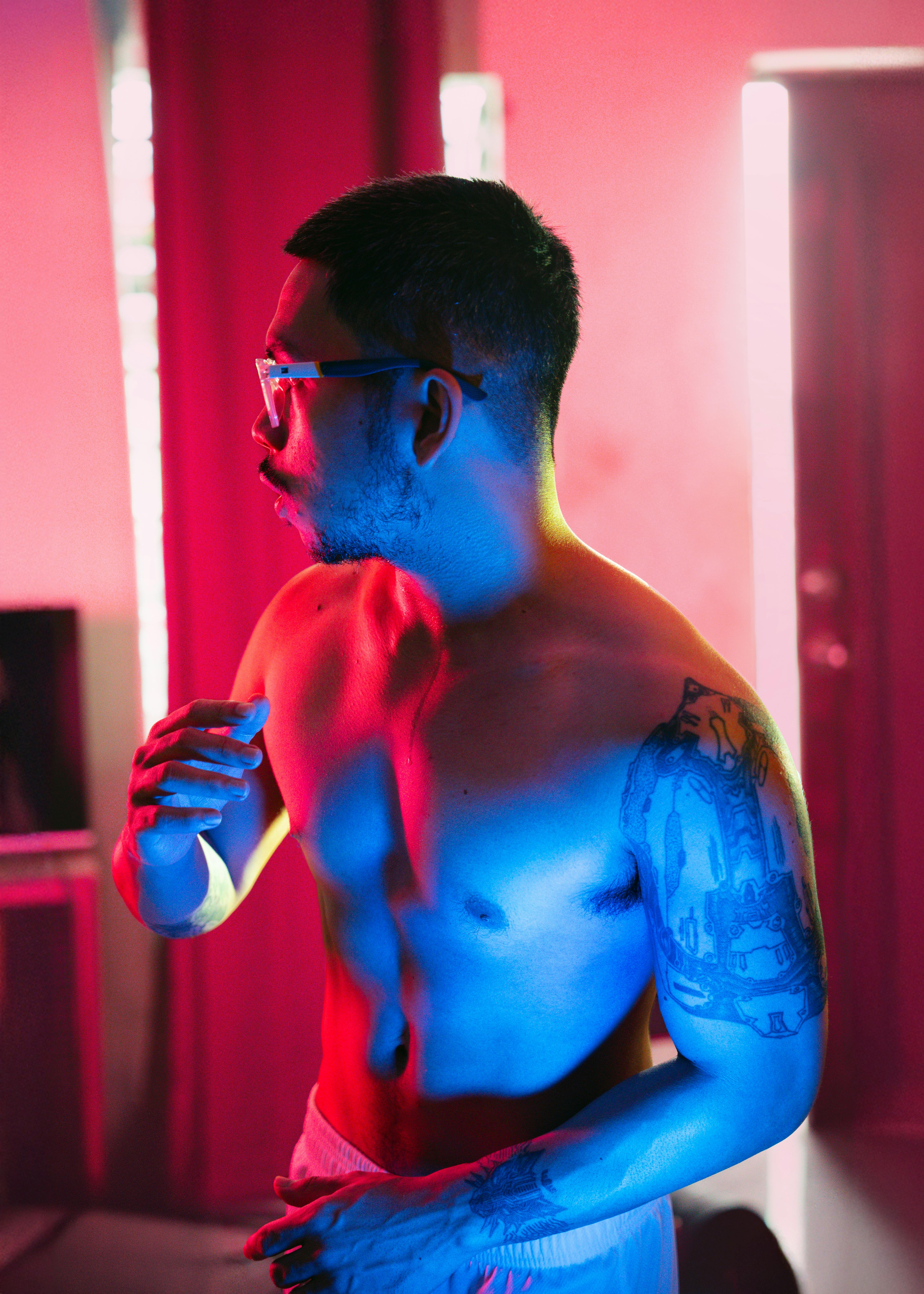 Vibrant Portrait of a Muscular Man with Tattoos · Free Stock Photo