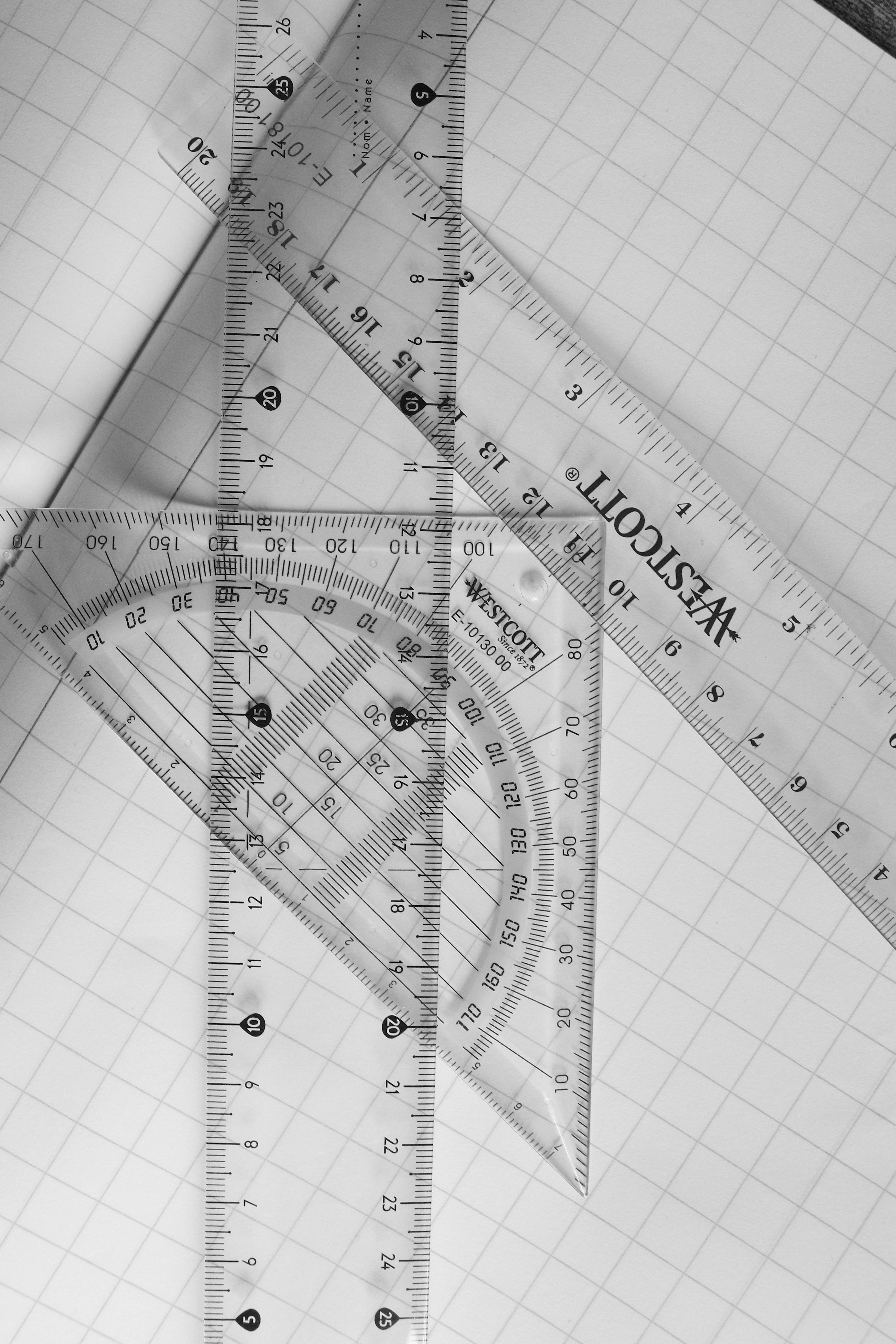 Black and White Geometric Rulers on Grid Paper · Free Stock Photo