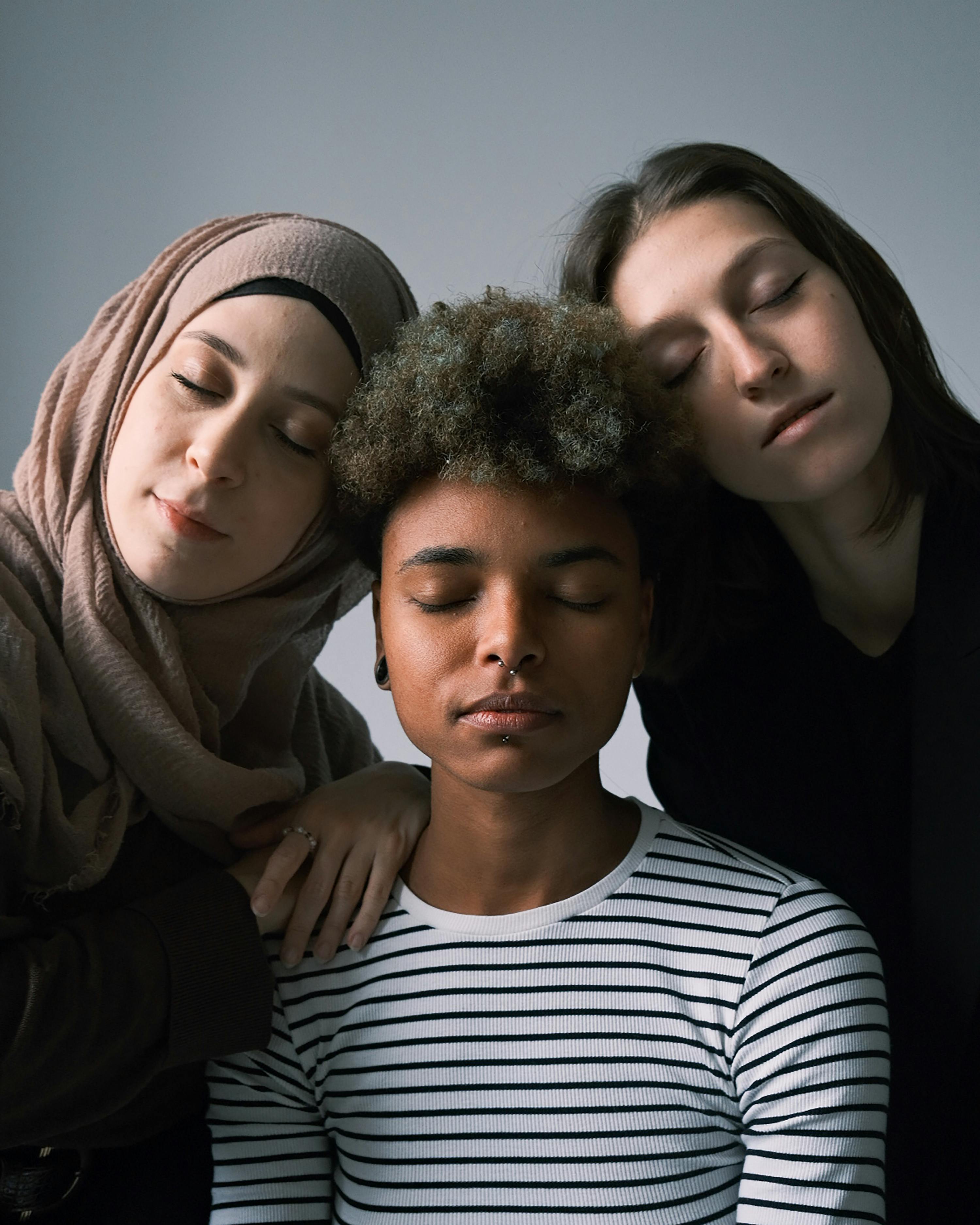 Diverse Unity: Three Women Embracing Peacefully · Free Stock Photo