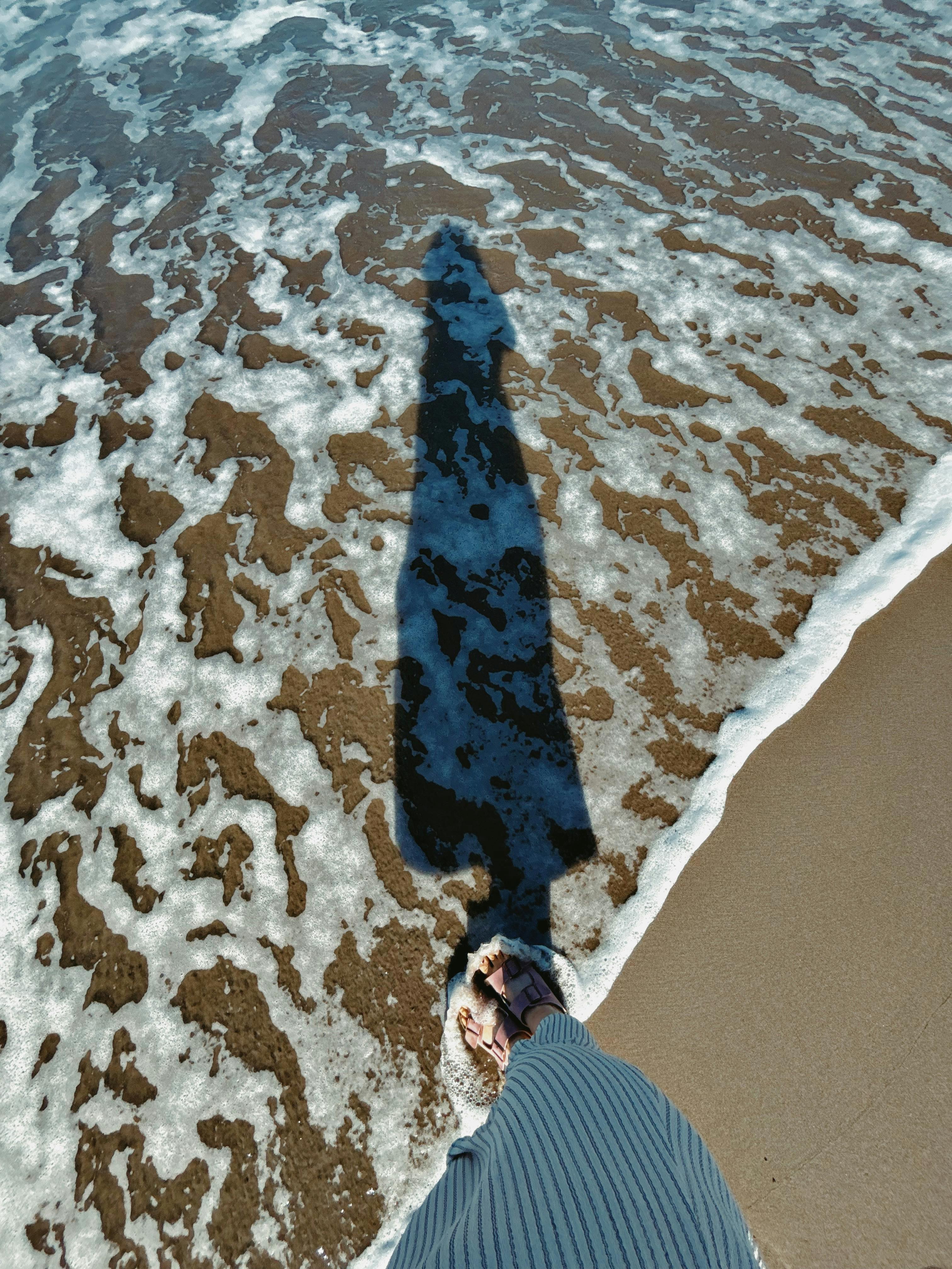Shadow on Beach Shoreline with Foam Waves · Free Stock Photo