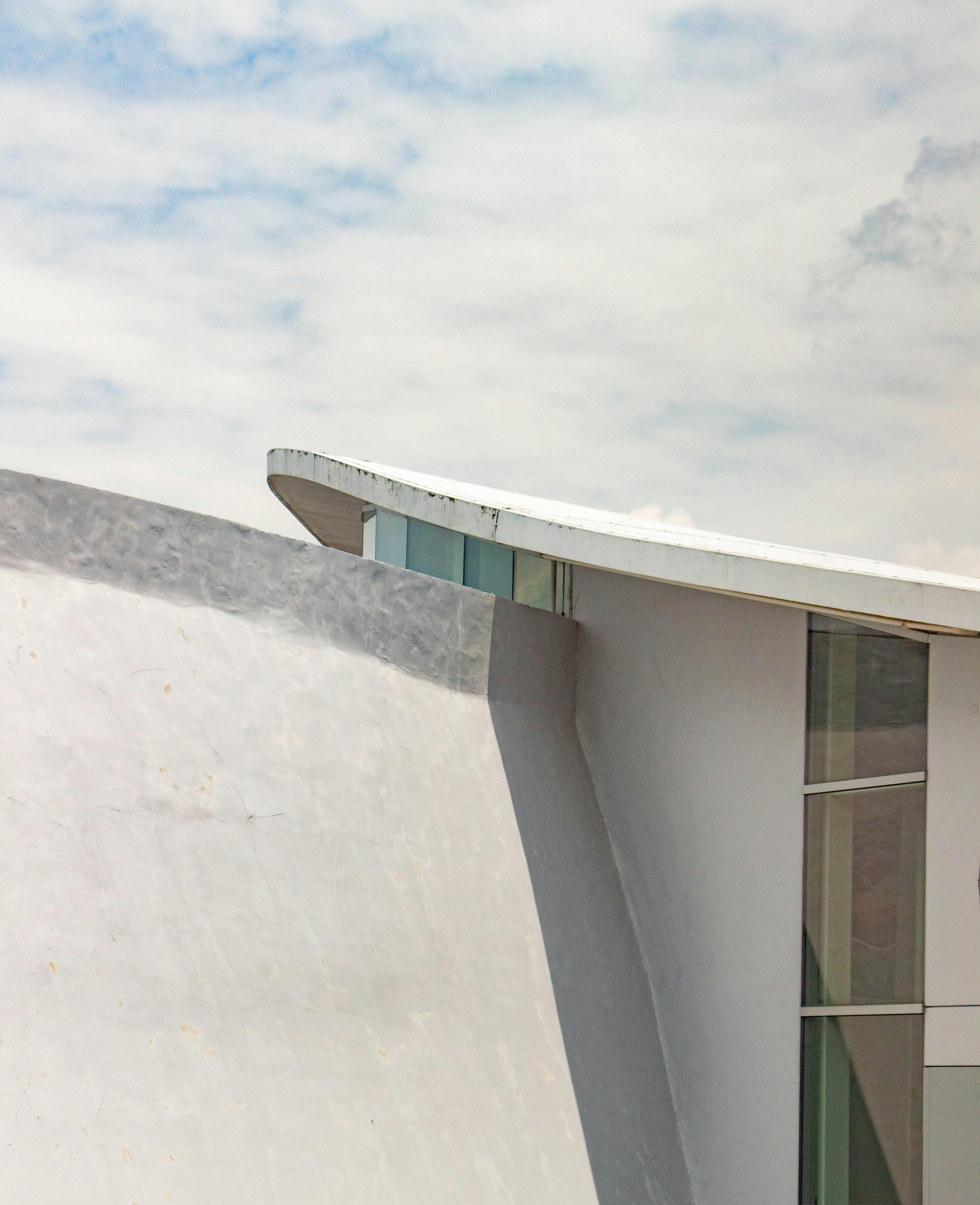 Modern Curved Concrete Structure with Glass · Free Stock Photo