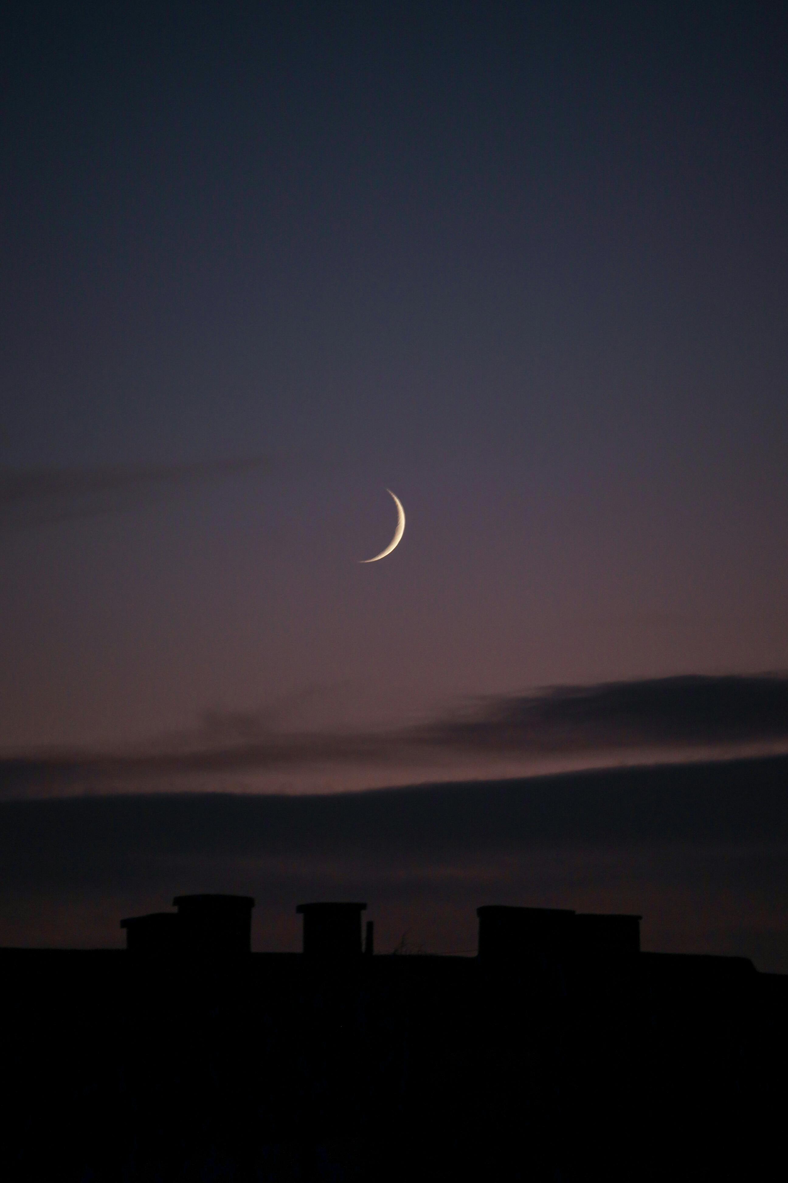 Crescent Moon and Silhouetted Rooftops at Twilight · Free Stock Photo