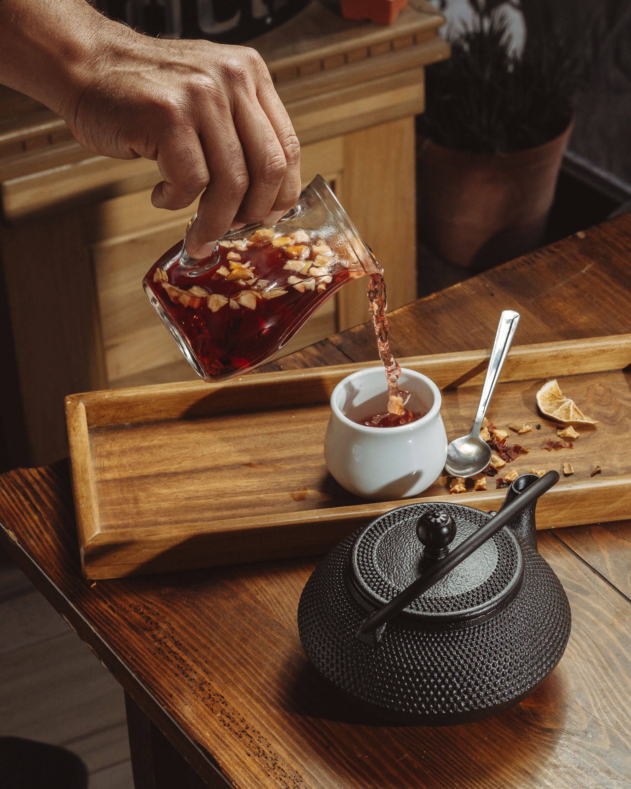 Pouring Herbal Tea in Rustic Indoor Setting · Free Stock Photo