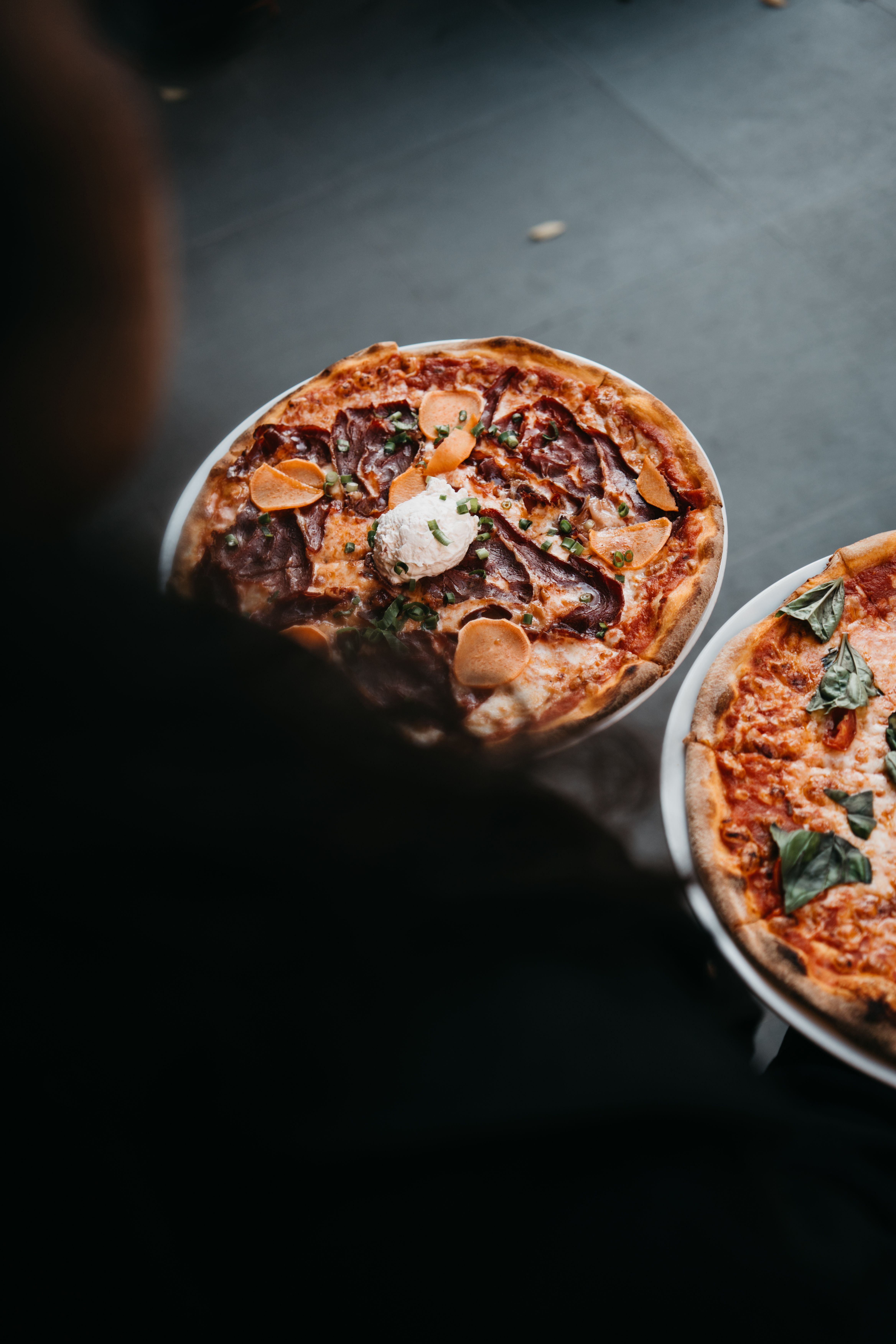 Close-up of Gourmet Pizzas on a Table · Free Stock Photo
