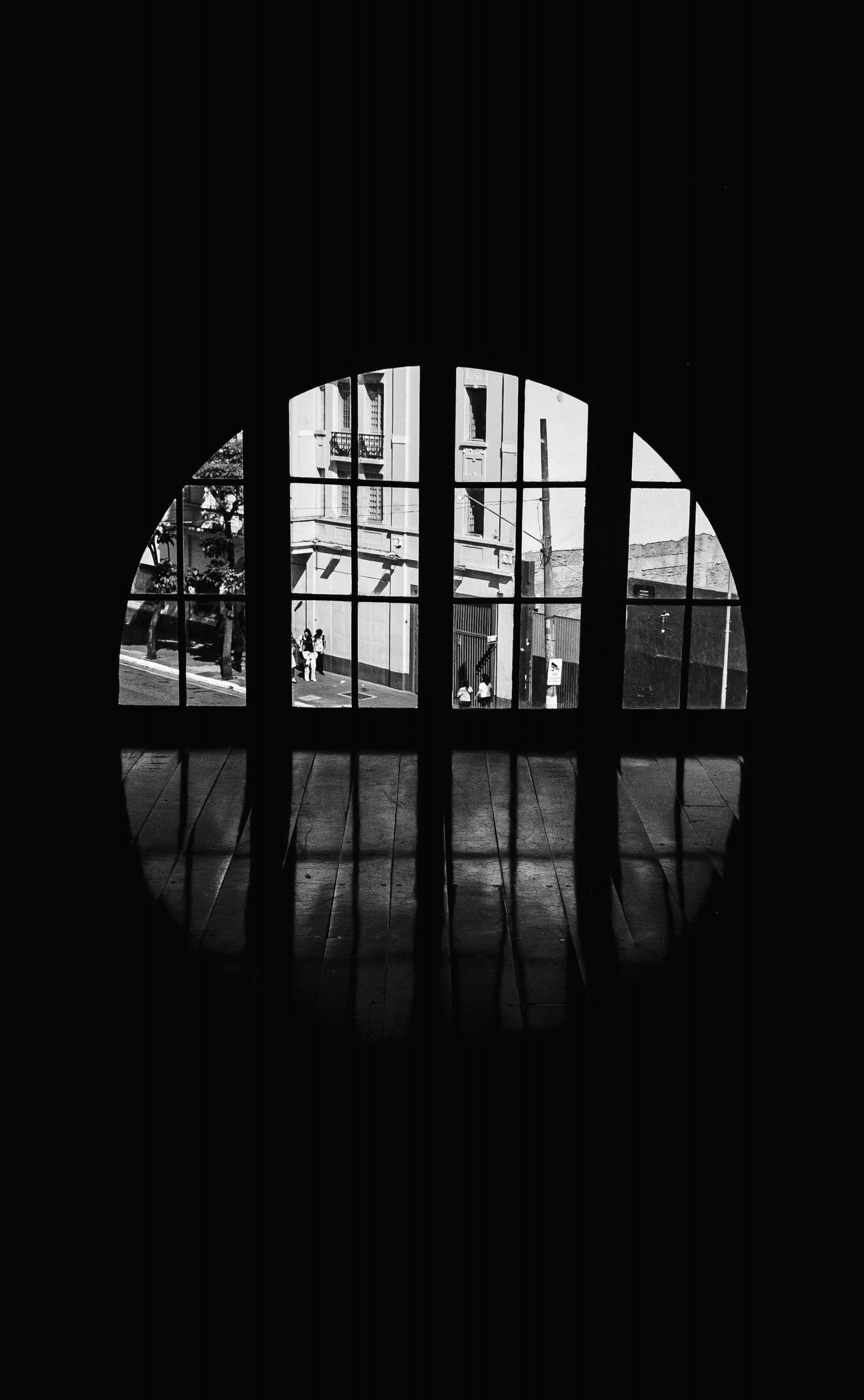 Urban Street View Through Circular Window Frame · Free Stock Photo