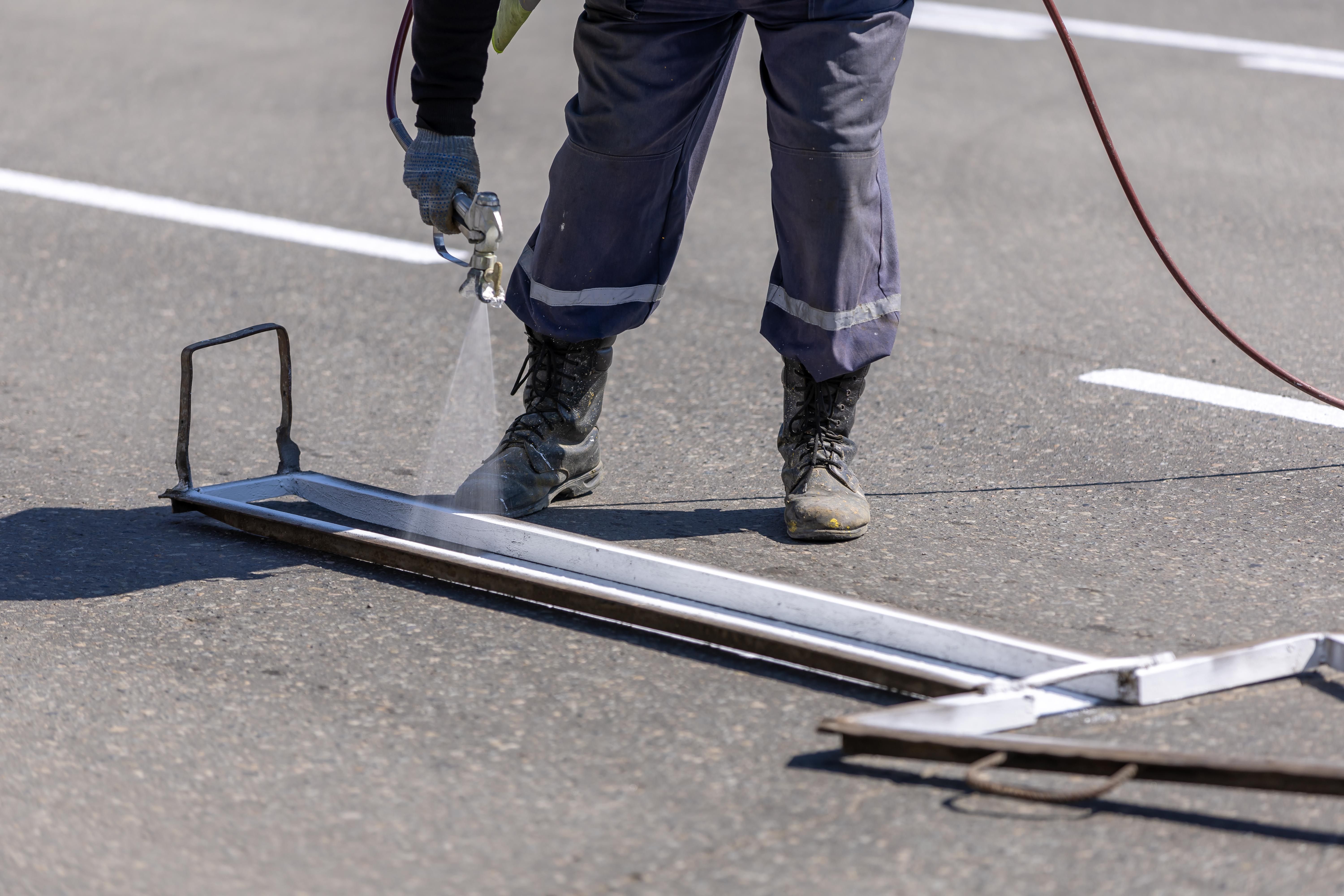 Worker Painting Road Lines During Daytime · Free Stock Photo
