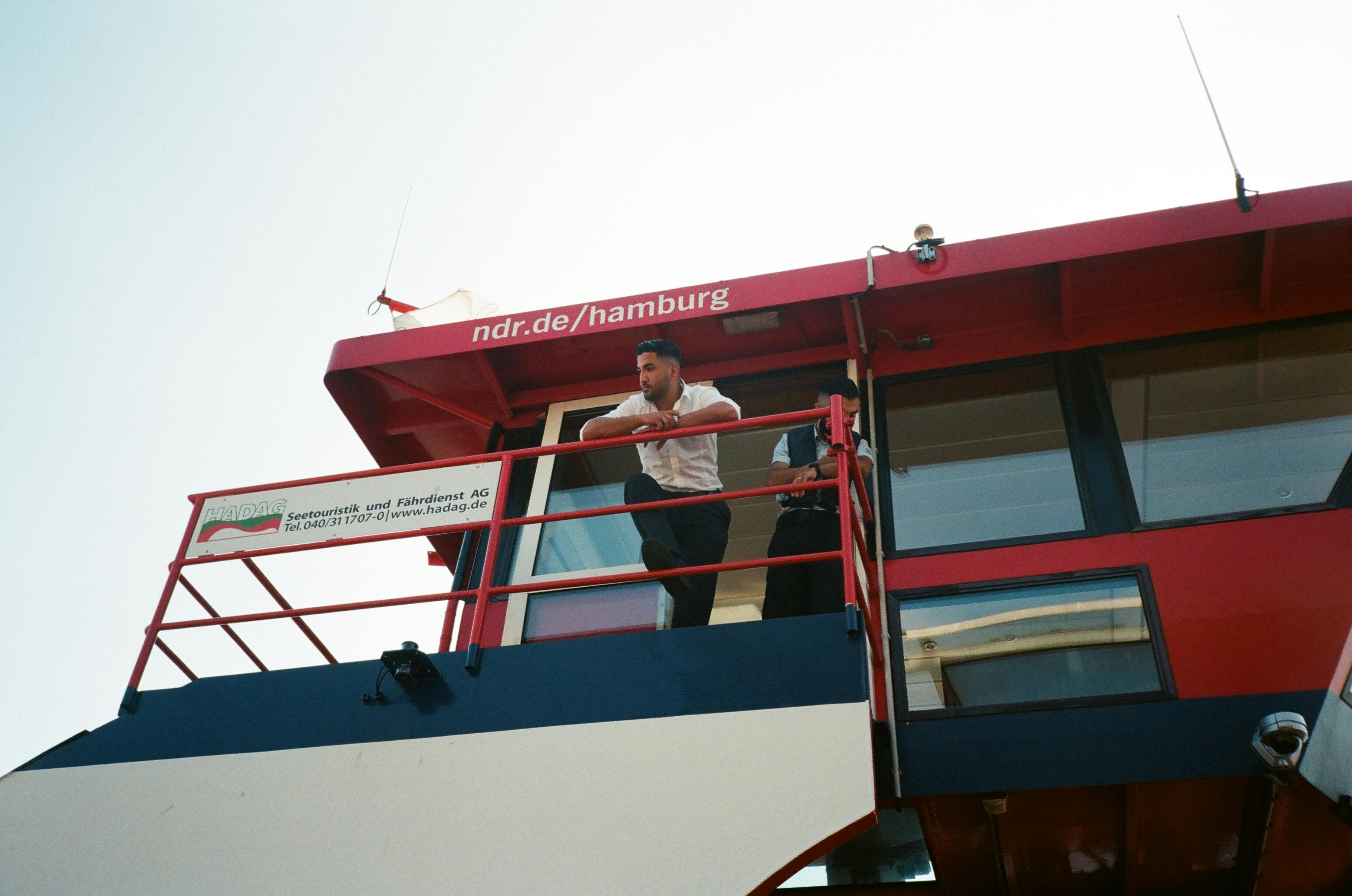 Men Leaning on Metal Railings while Having a Conversation · Free Stock ...
