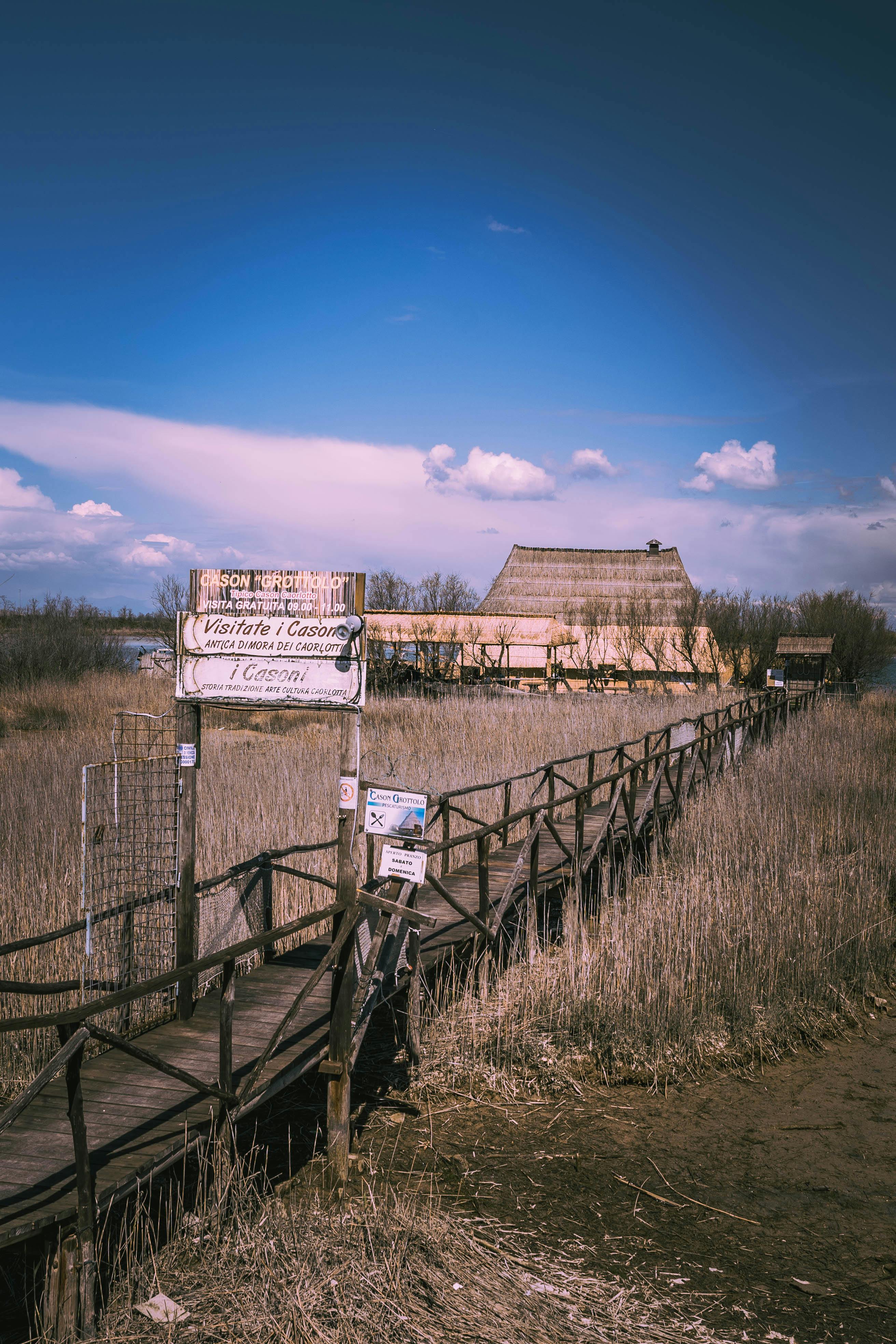Rustic Wooden Pathway to Traditional Thatched Building · Free Stock Photo