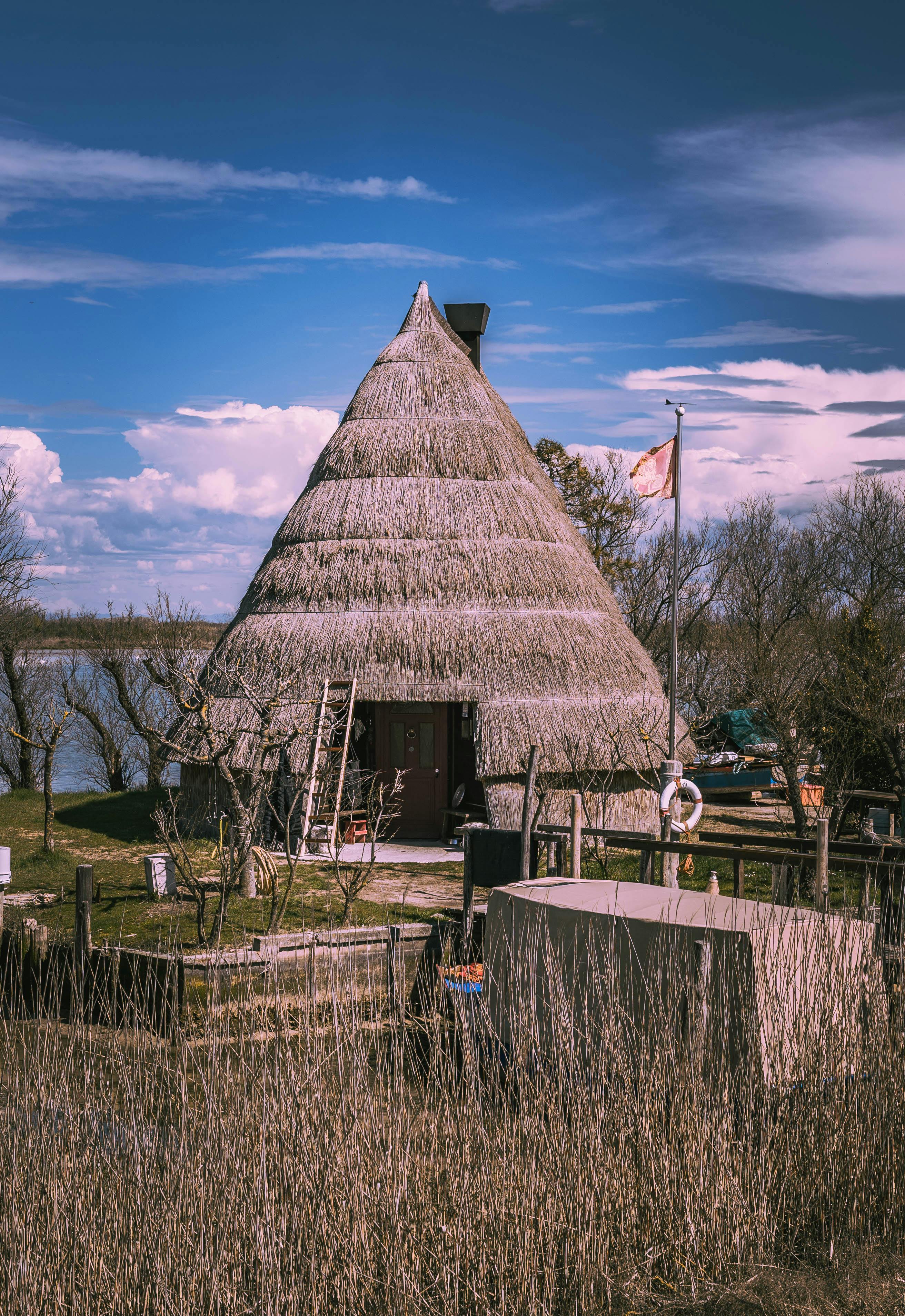 Traditional Rural Thatched Hut by the Lake · Free Stock Photo