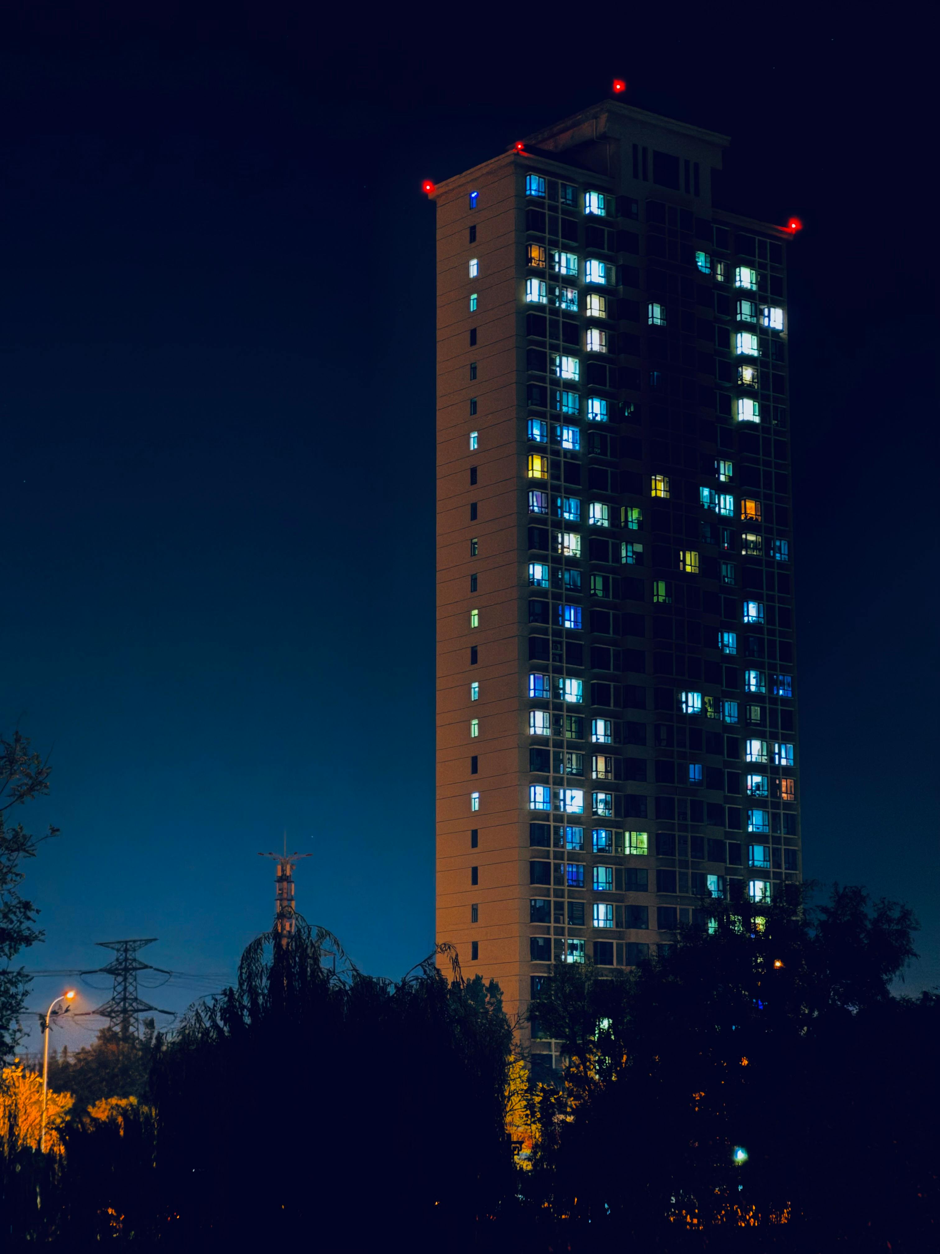 Illuminated High-Rise Building at Night · Free Stock Photo
