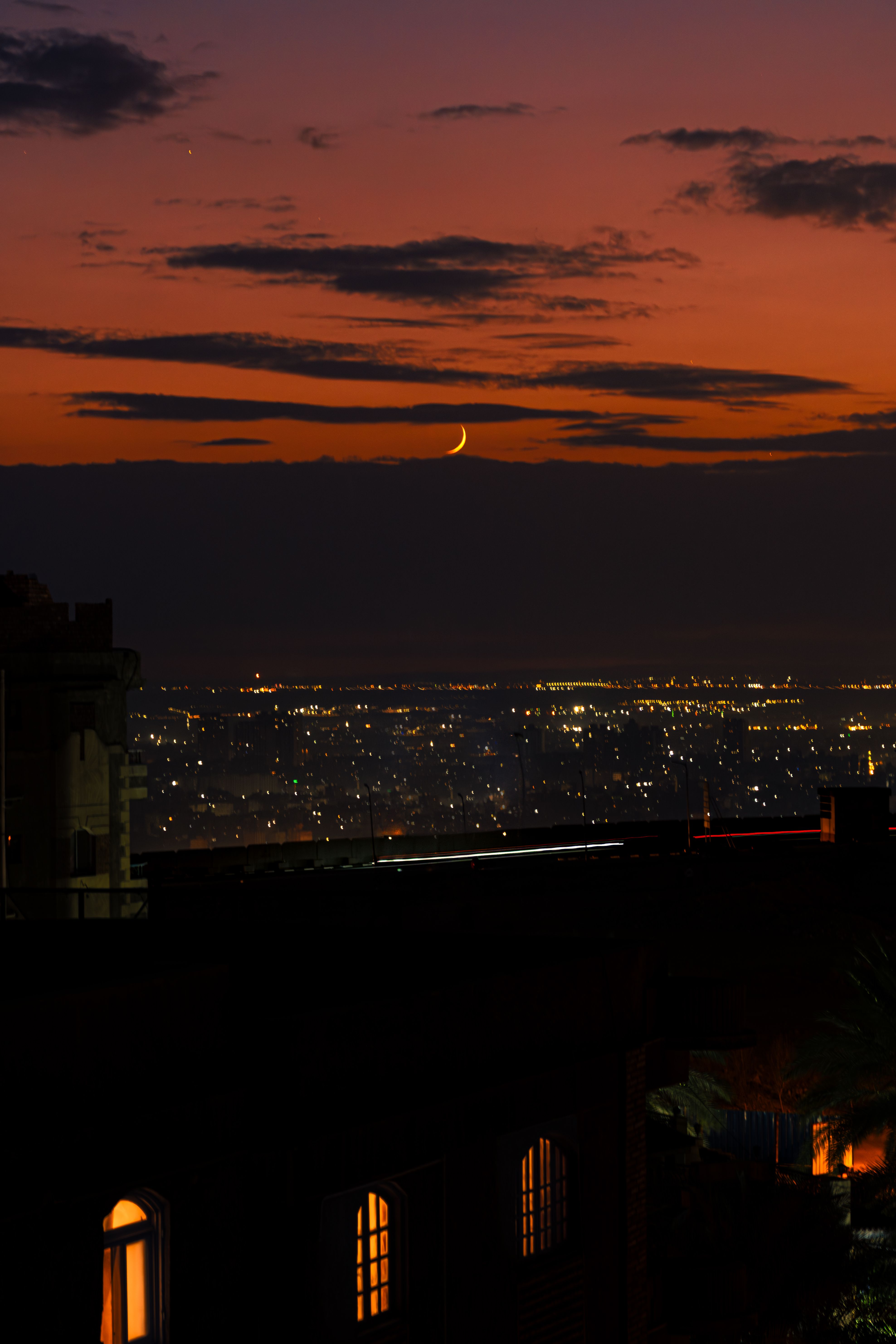 Beautiful Sunset Over Cairo Cityscape with Crescent Moon · Free Stock Photo